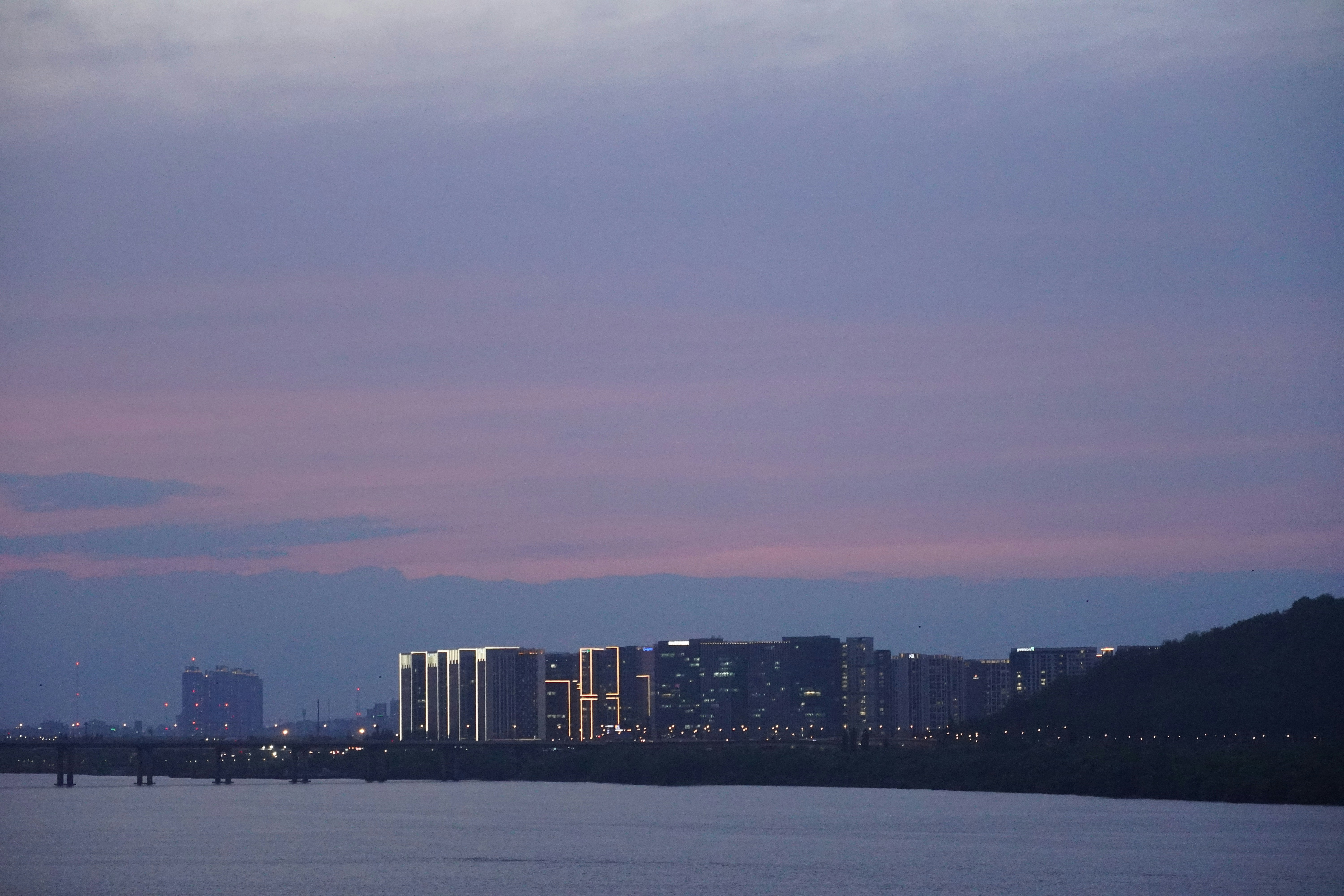 Evening Waterfront Skyline: Quiet Lights Along the River