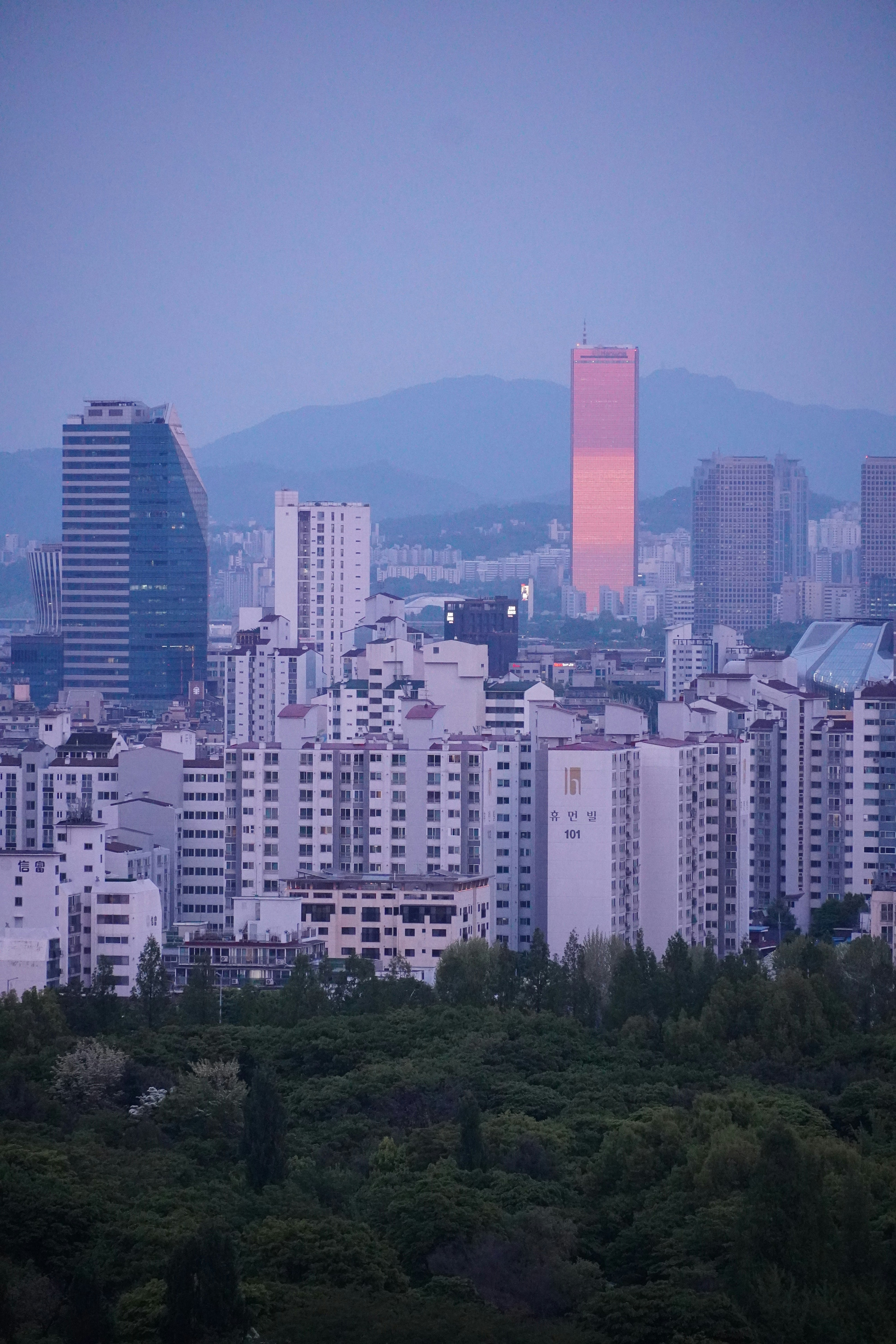 Rising Skyline: A Copper-tinted Tower Among a Sea of White