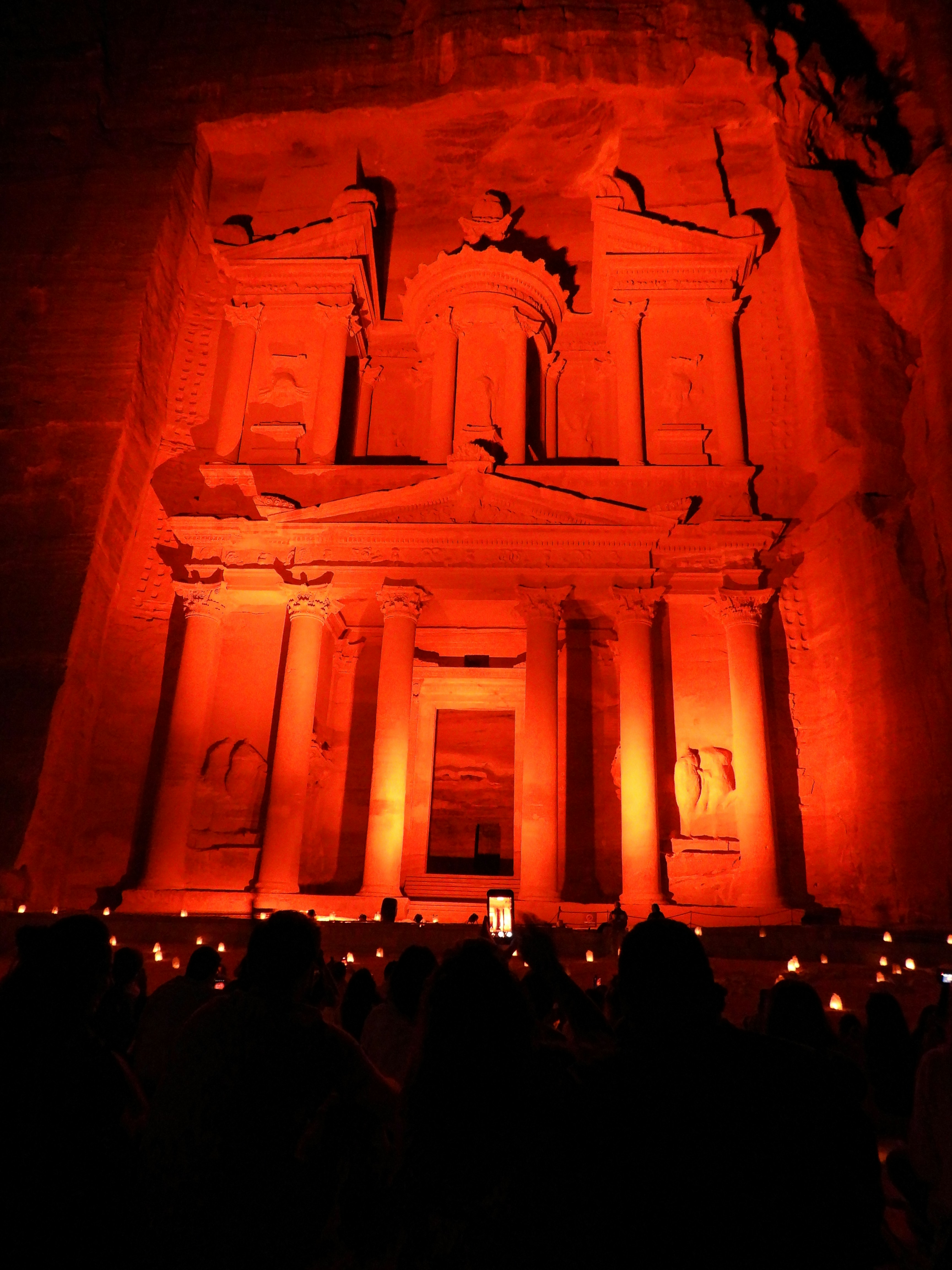 Carved facade lit in crimson: all eyes on the towering temple doorway