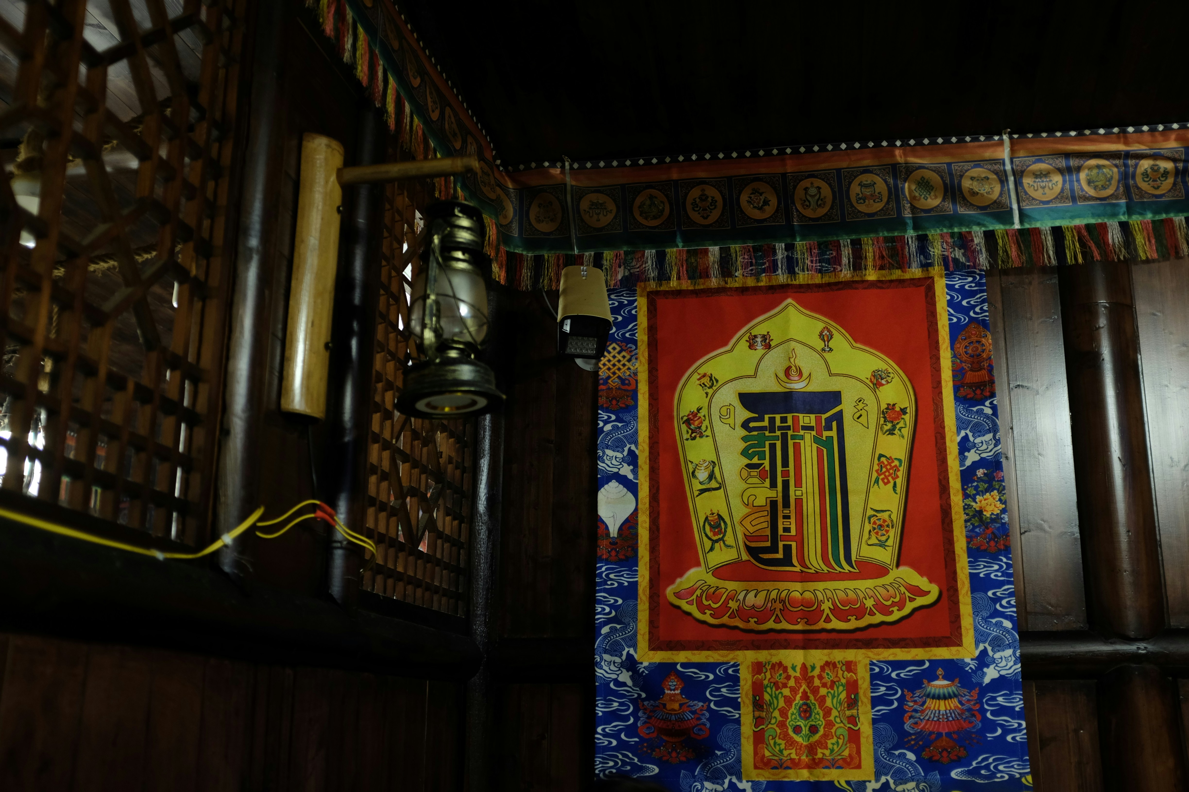 Hanging Lamplight and Sacred Banner in Dim Temple Hall