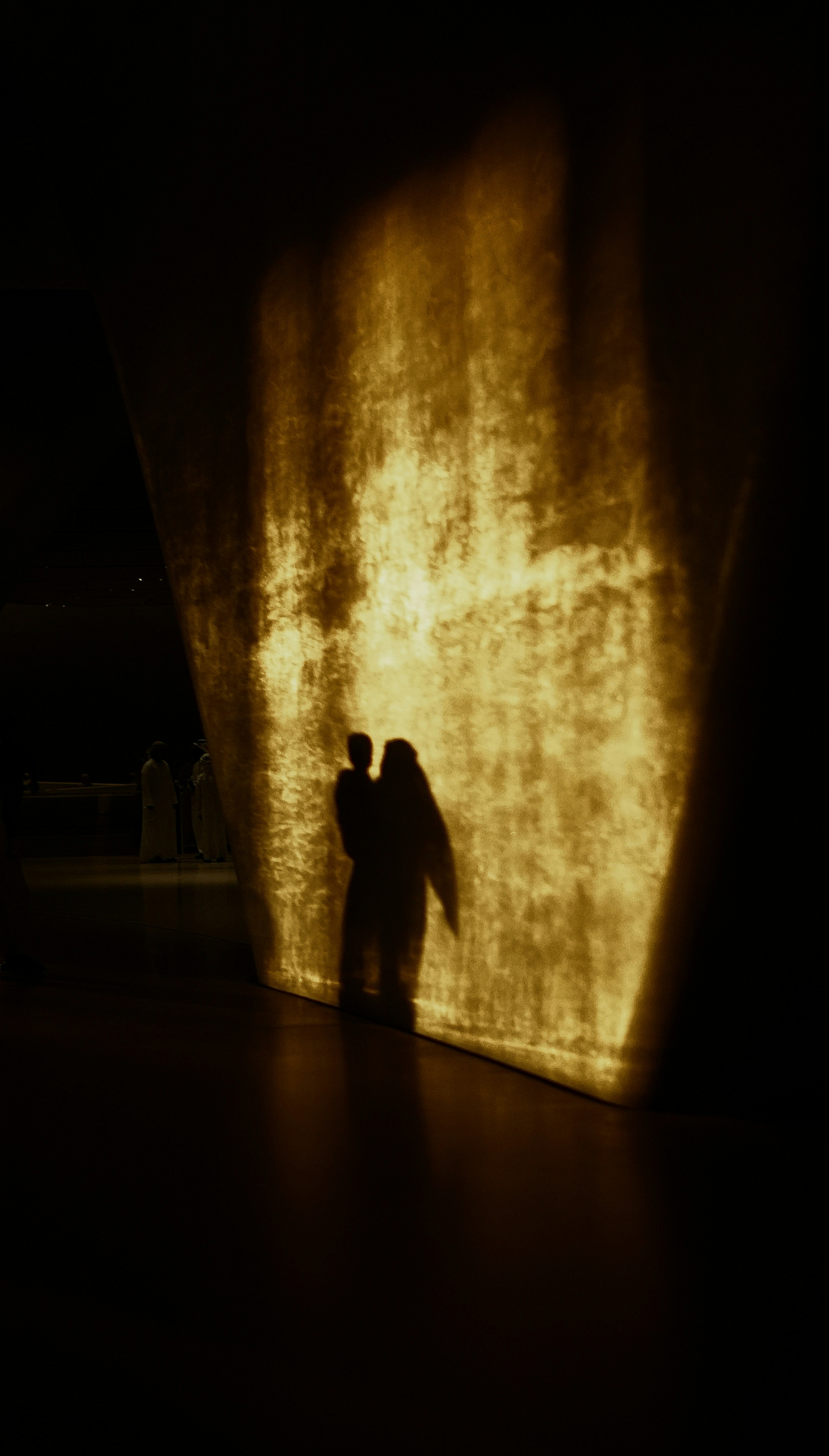 Golden Curtain: Lovers in Shadow on a Shimmering Wall