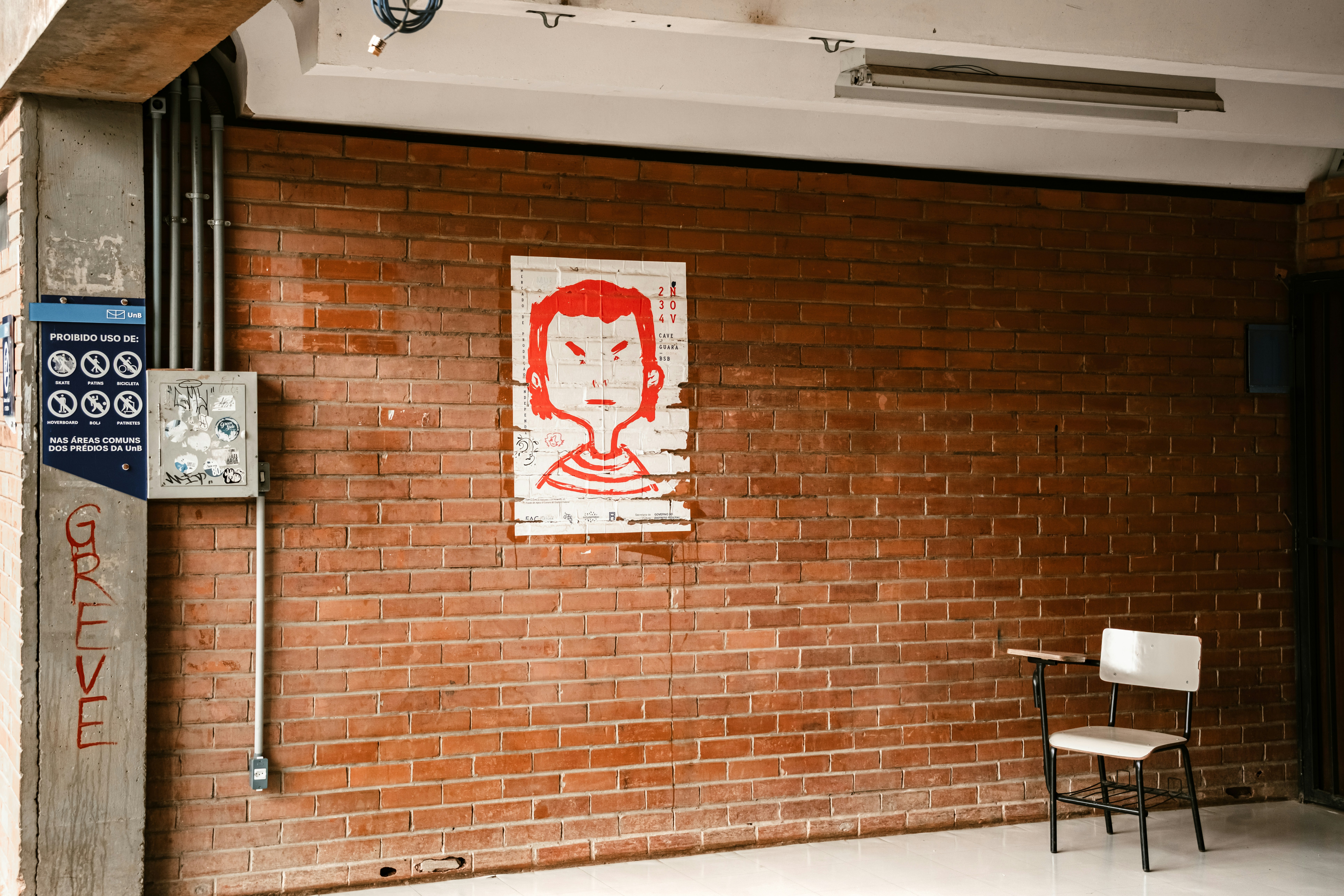 Red Portrait on a Brick Wall: Quiet Corner with a Single Chair