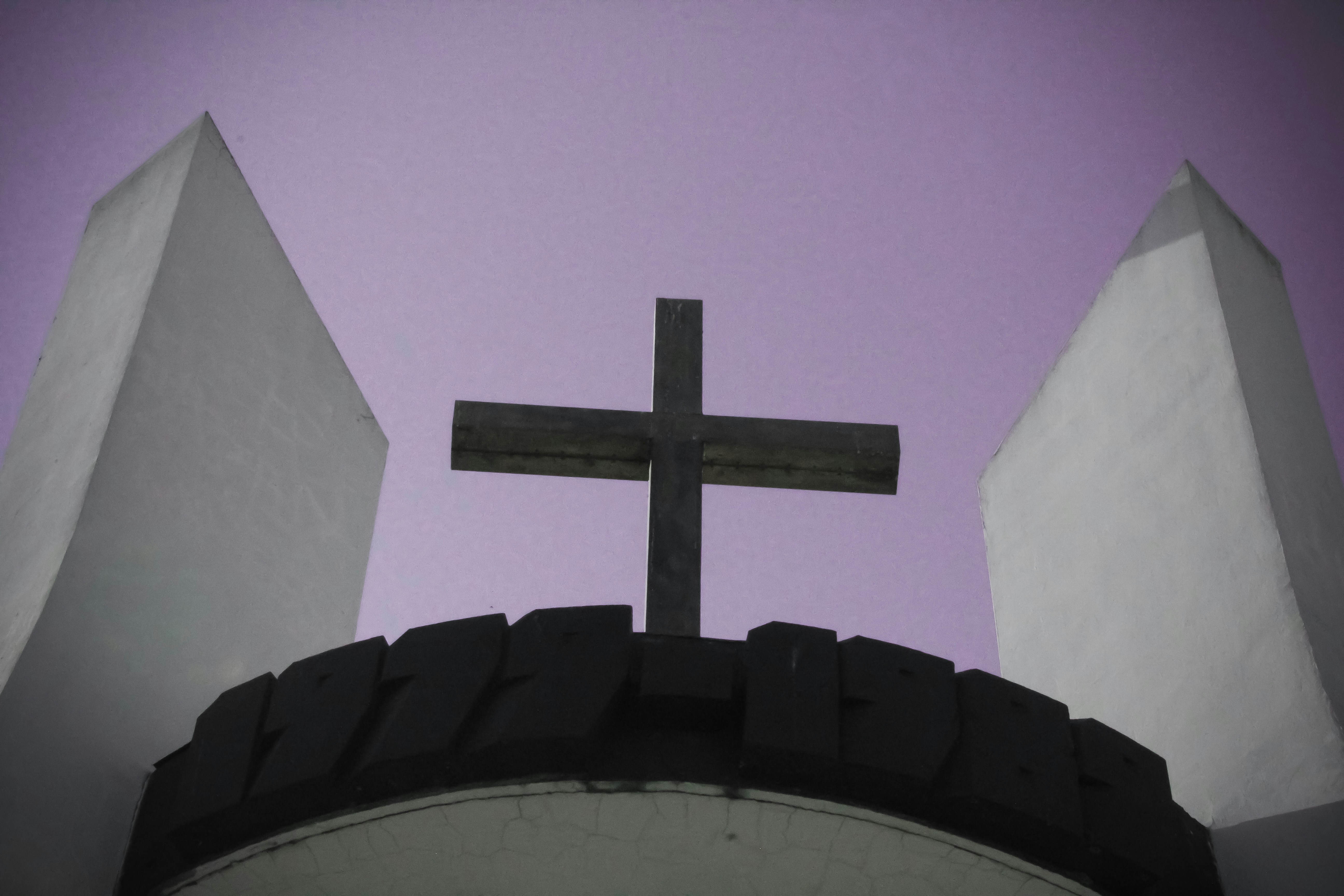 Cross Above the Circular Roof: A Stilled Moment at Dusk