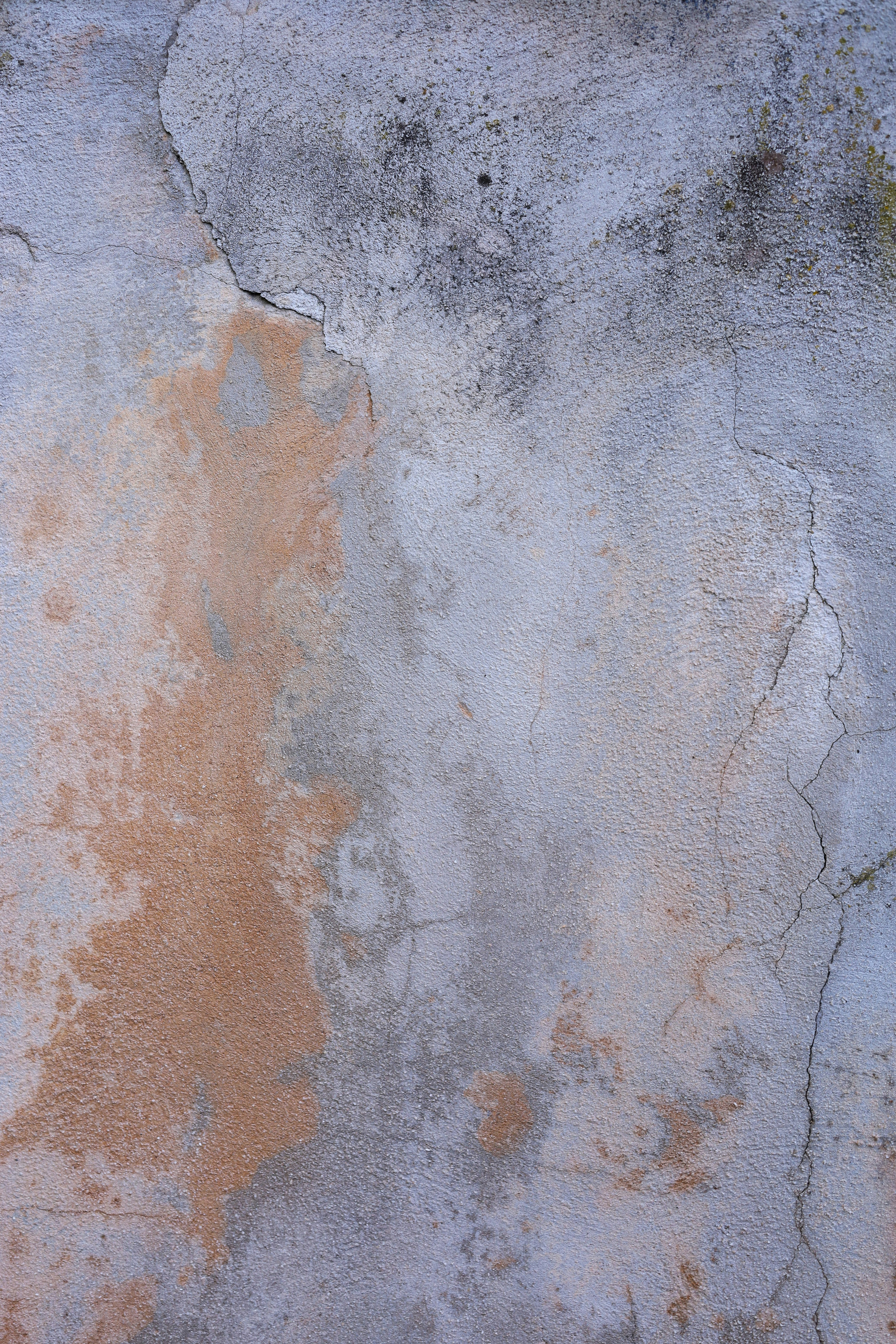 Weathered Wall with Fading Colors and Cracks