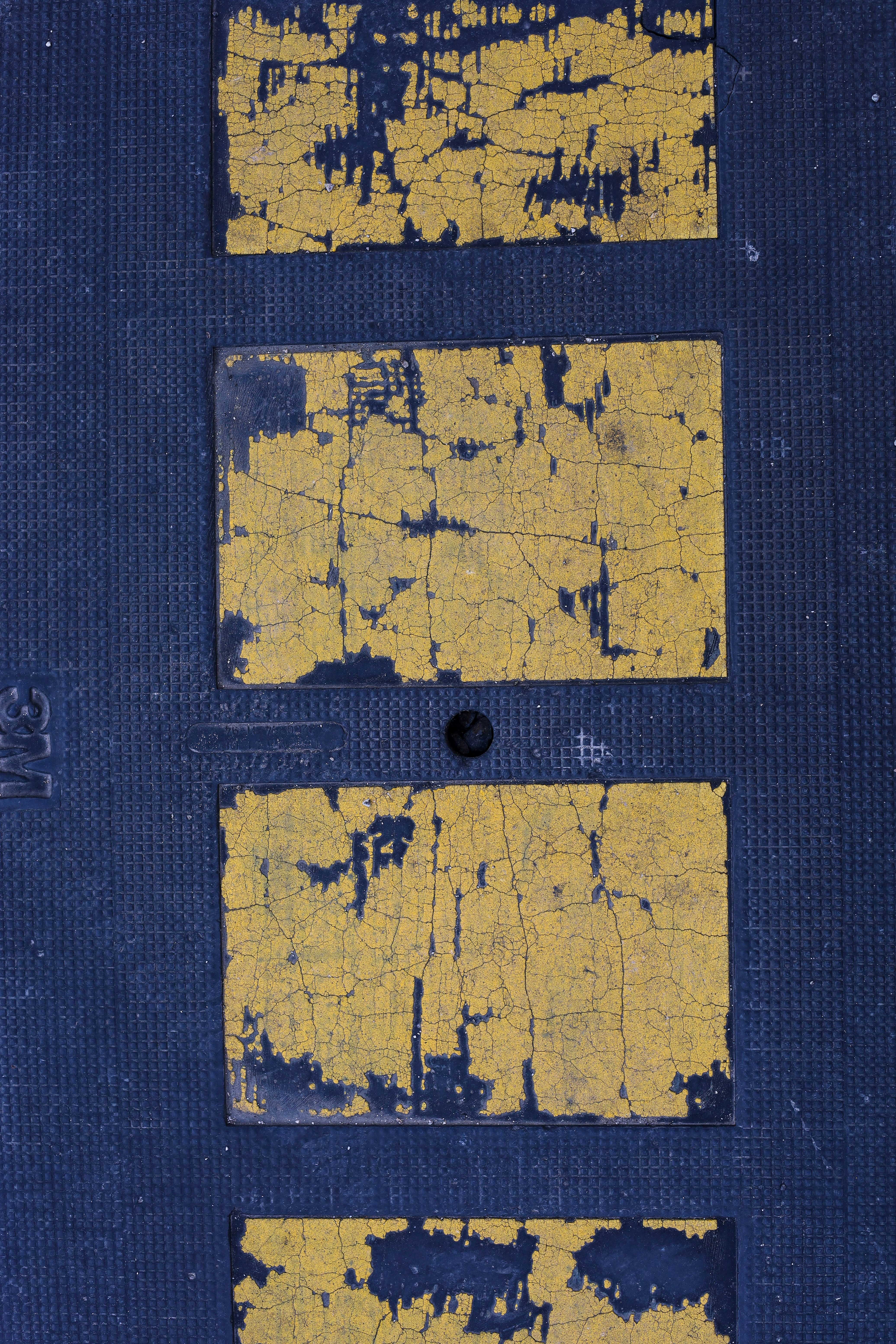 Cracked Gold on Blue: Weathered Safety Strip Portrait