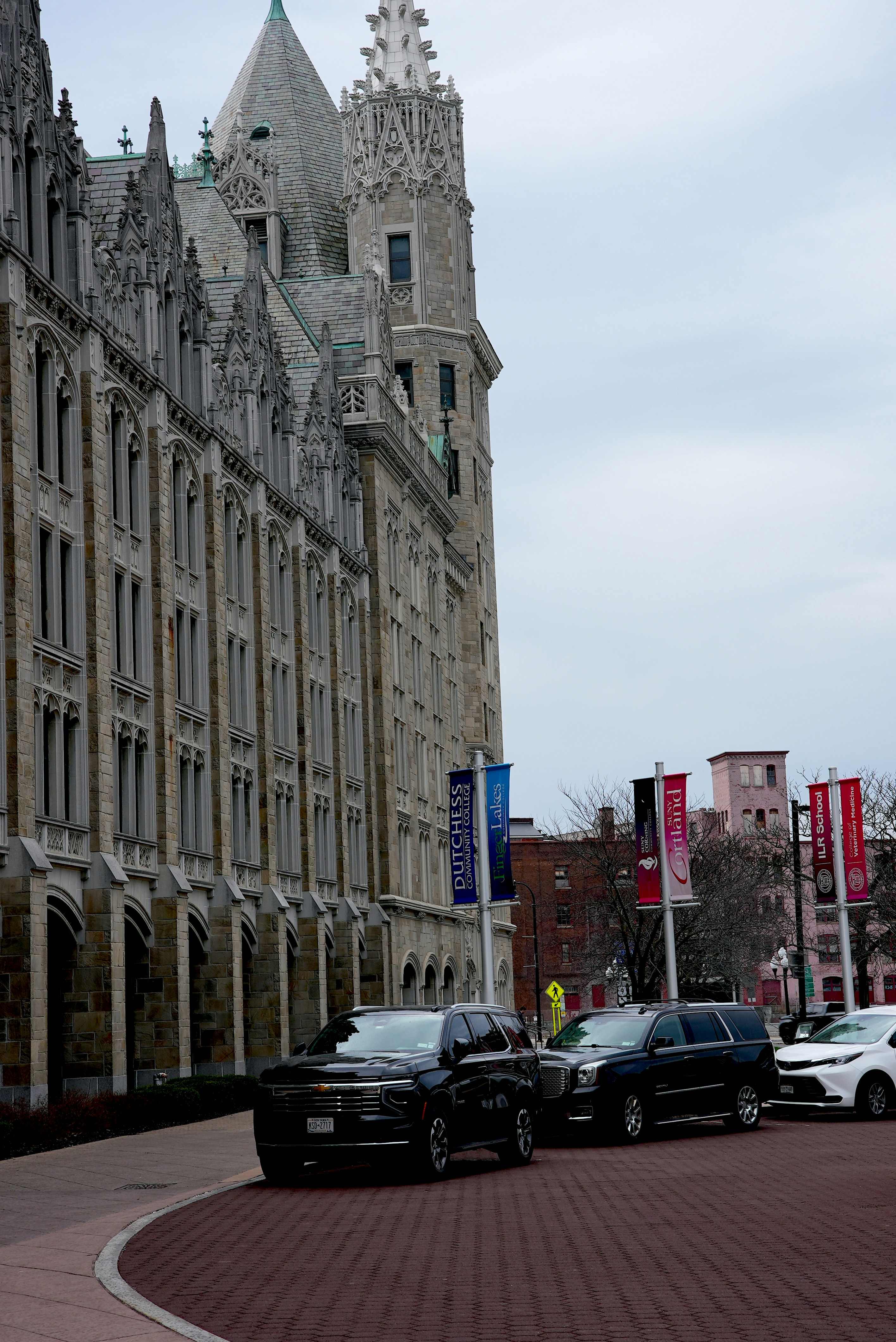Gothic Facade Boulevard: Car-lined Approach to the Arched Campus Tower