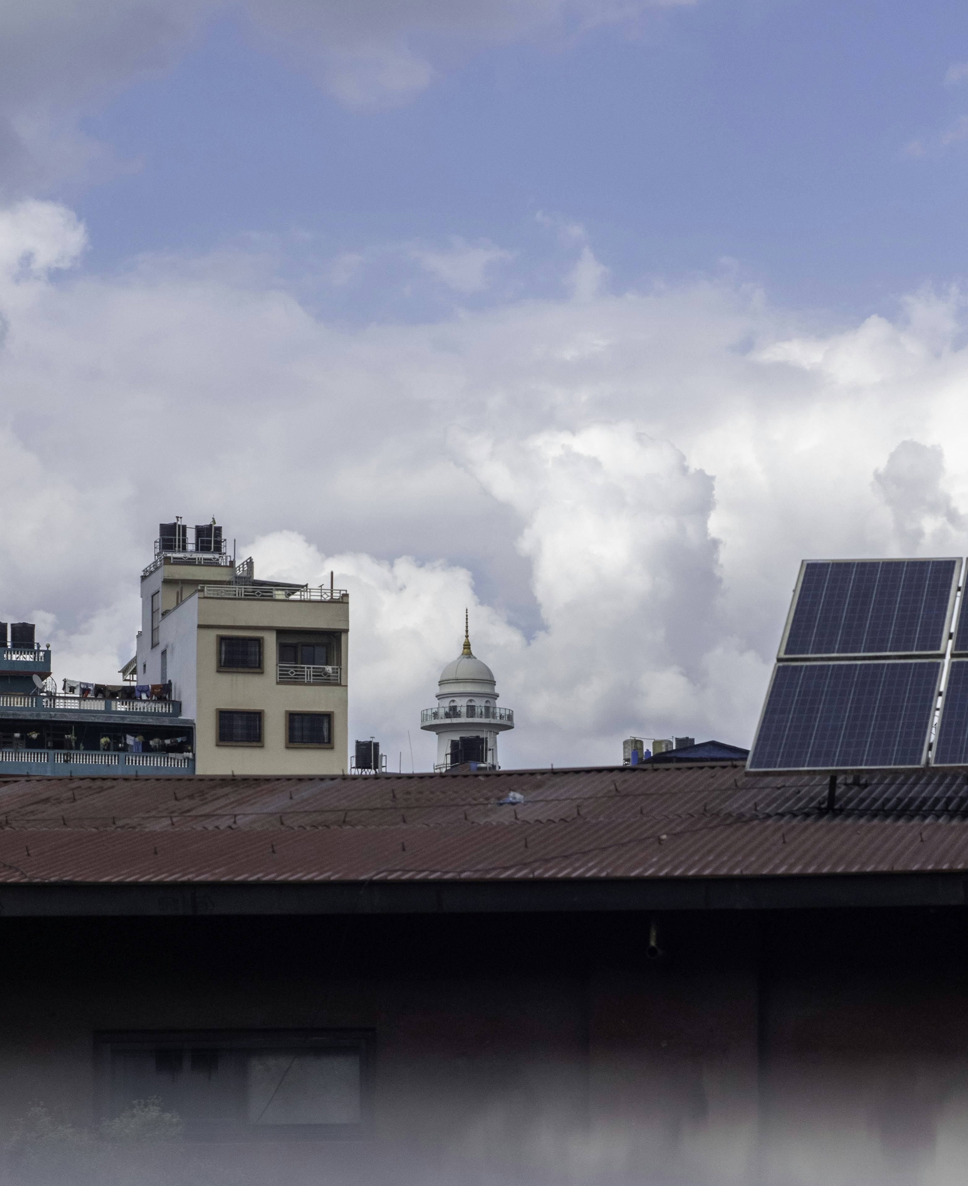 Solar-Rooftop Silhouette Under a City Sky