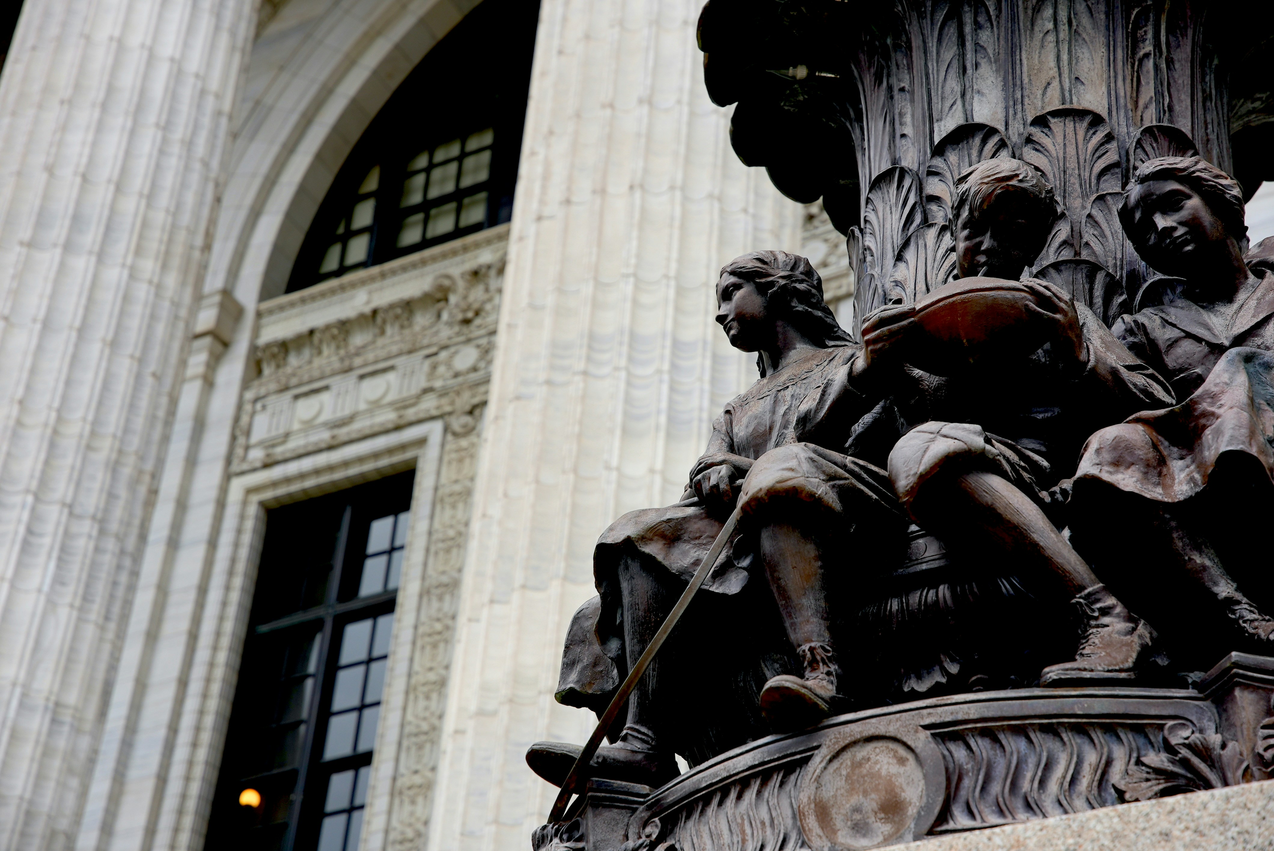 Stone Choir: A Bronze Relief against Marble Grandeur