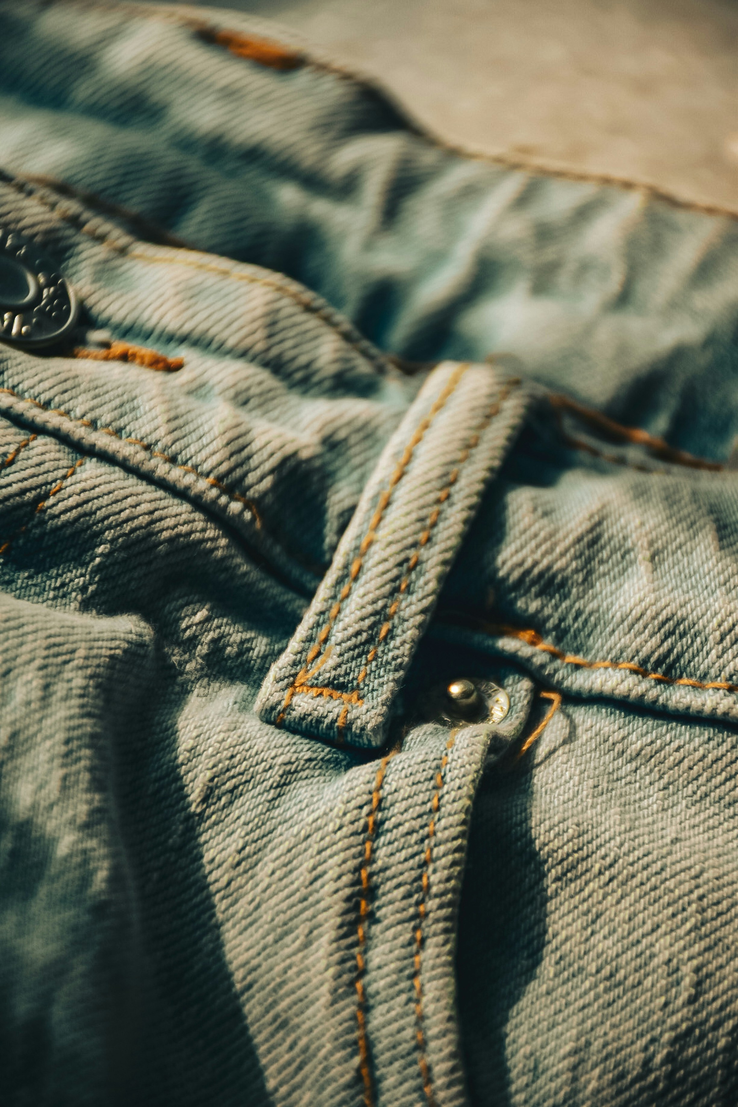 Stitched Denim Details: Close-up of a Weathered Jeans Pocket