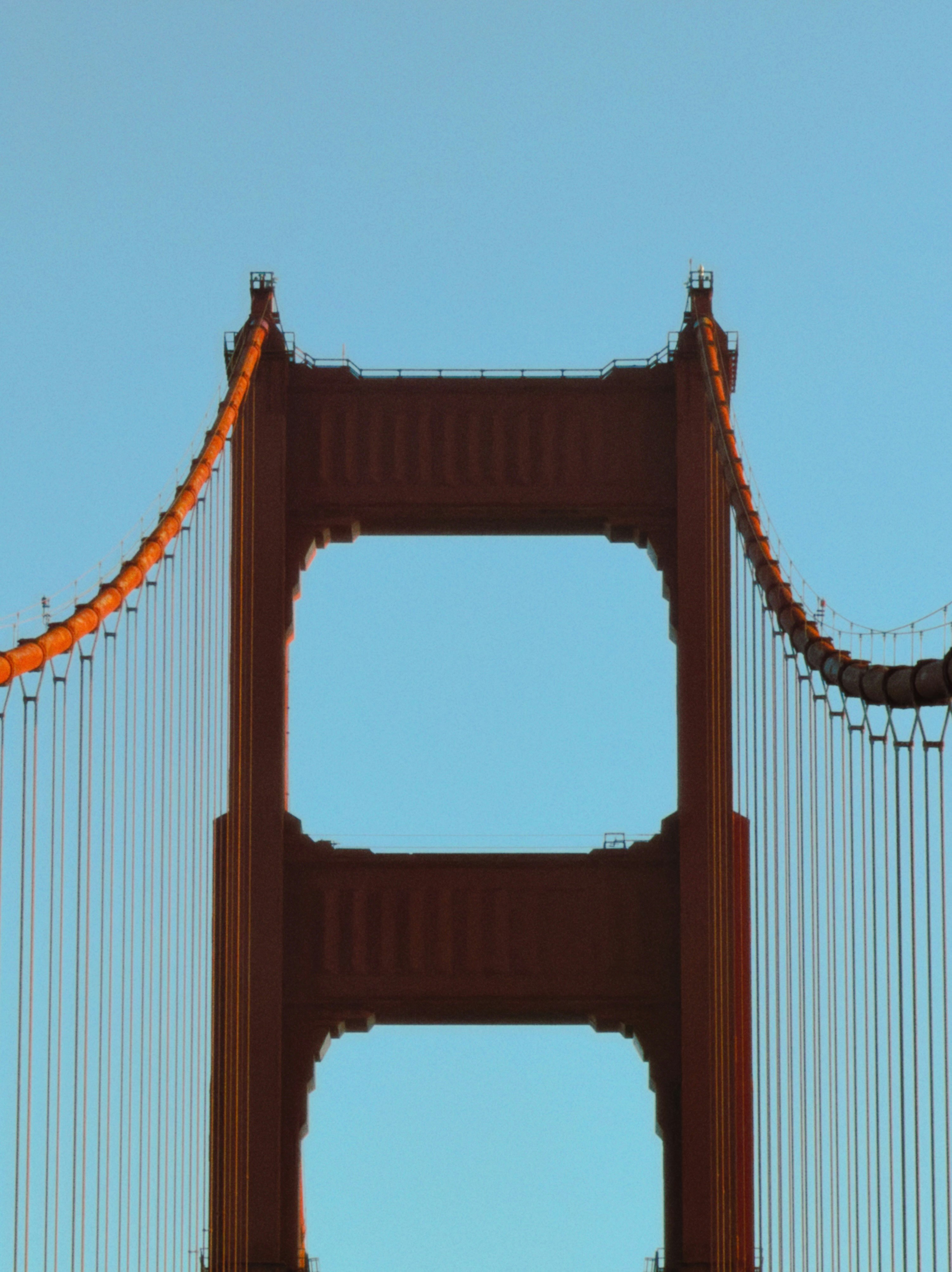 Red Tower Looming Against a Clear Sky: A Strut-Focused Golden Gate