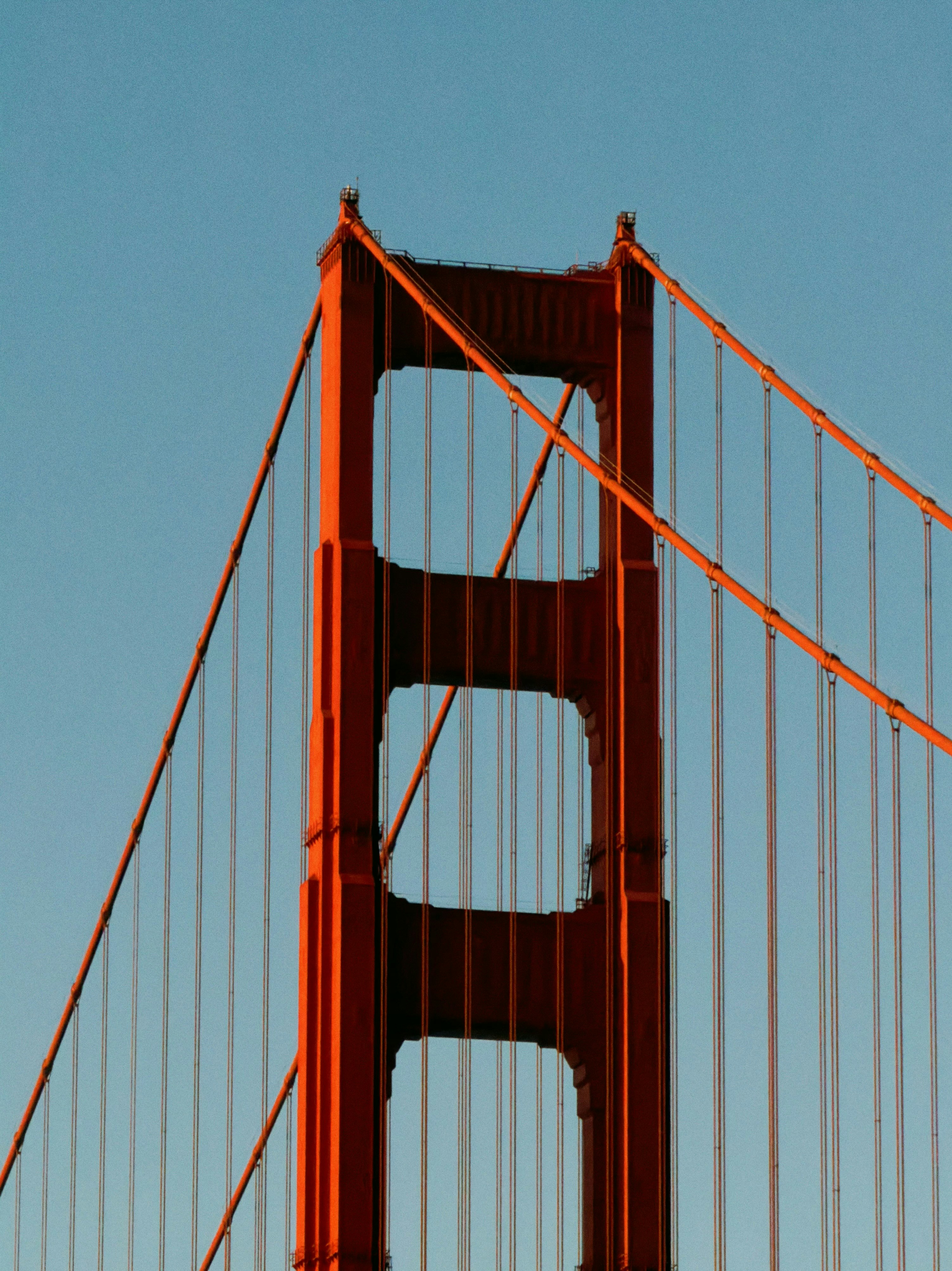 Riveted Horizon: The Golden Gate's Red Profile Against a Calm Sky