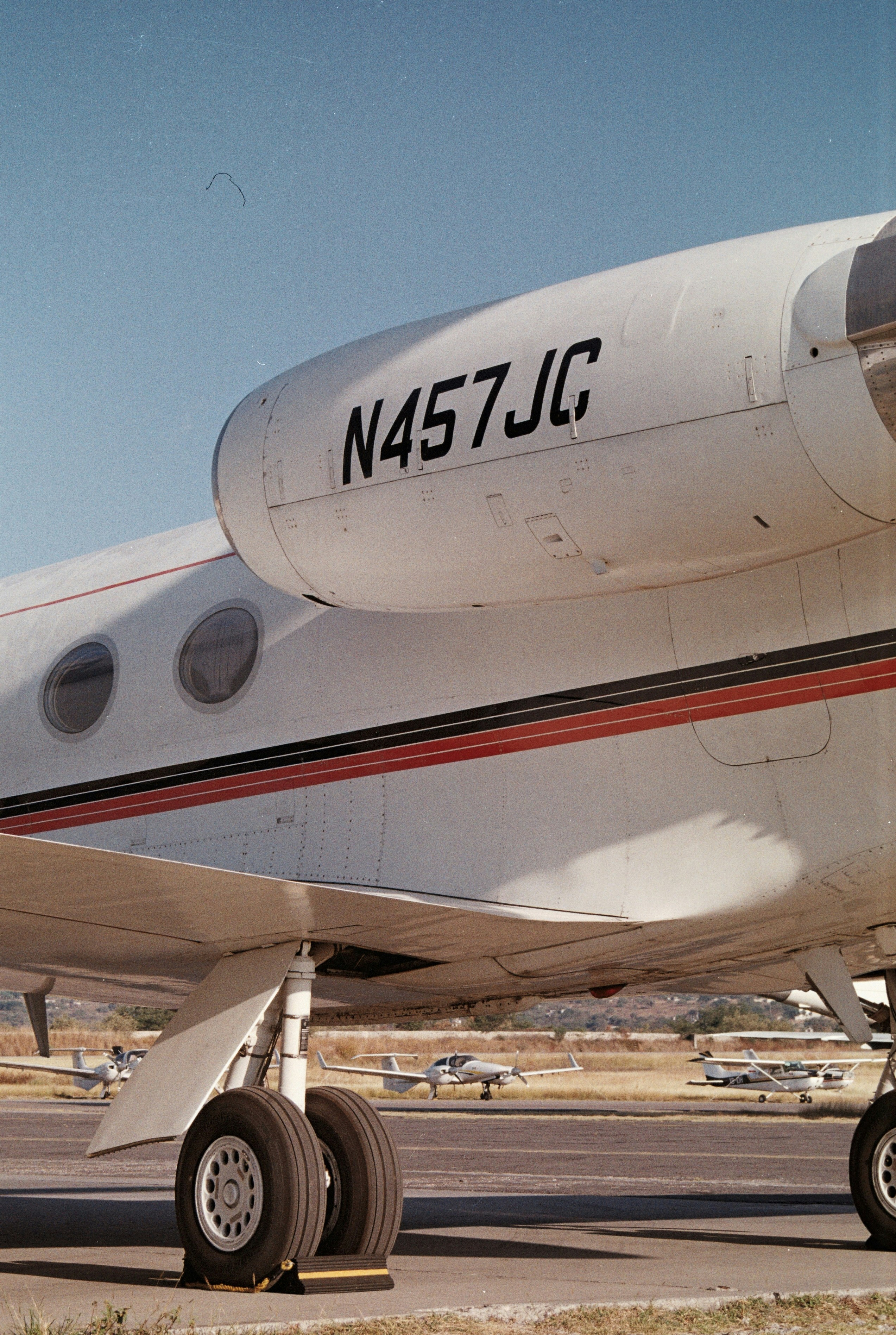 Nose-Toned Jet: Close-Up of Tail Section and Gear at the Tarmac