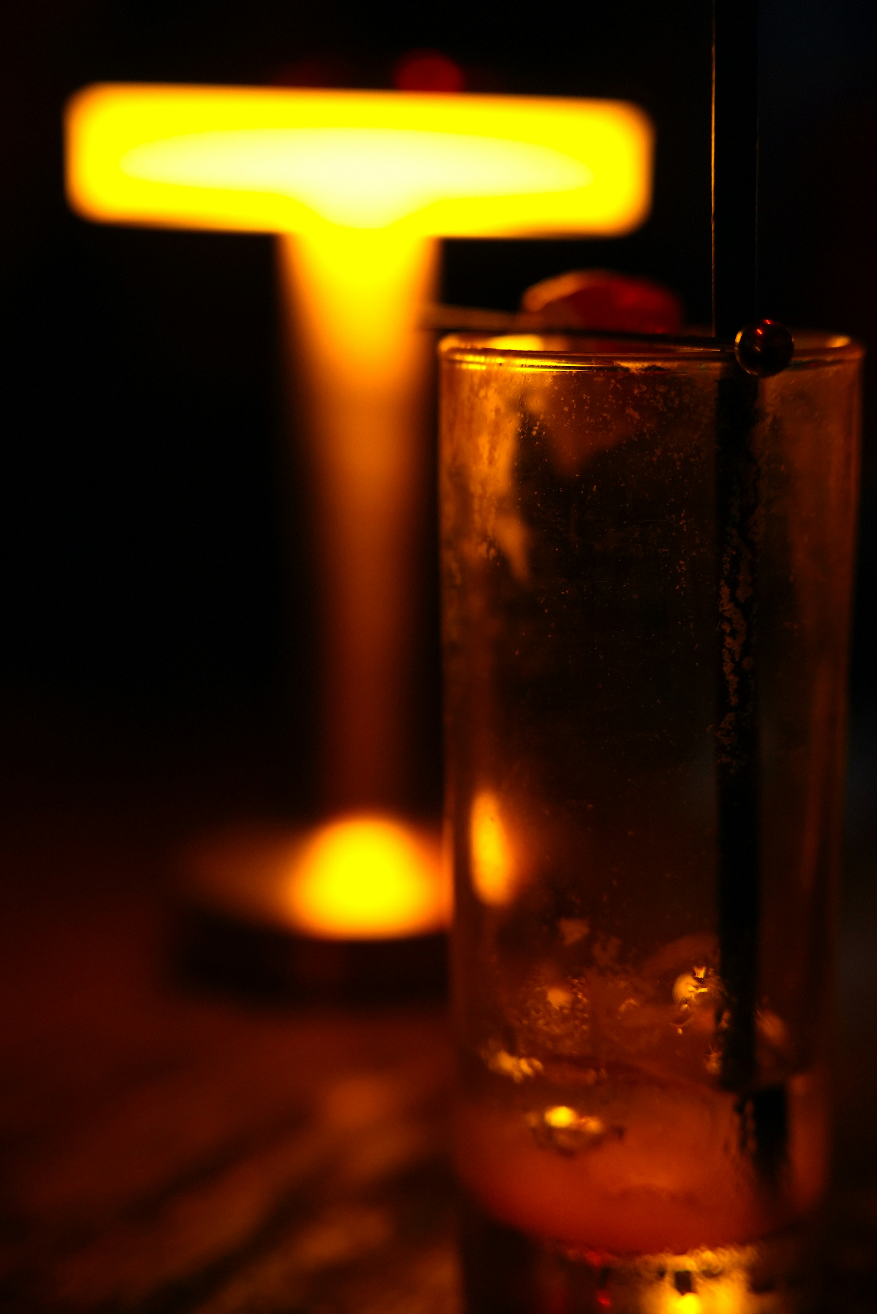 Warm Amber Focus: A Glass of Nightlight in the Blur