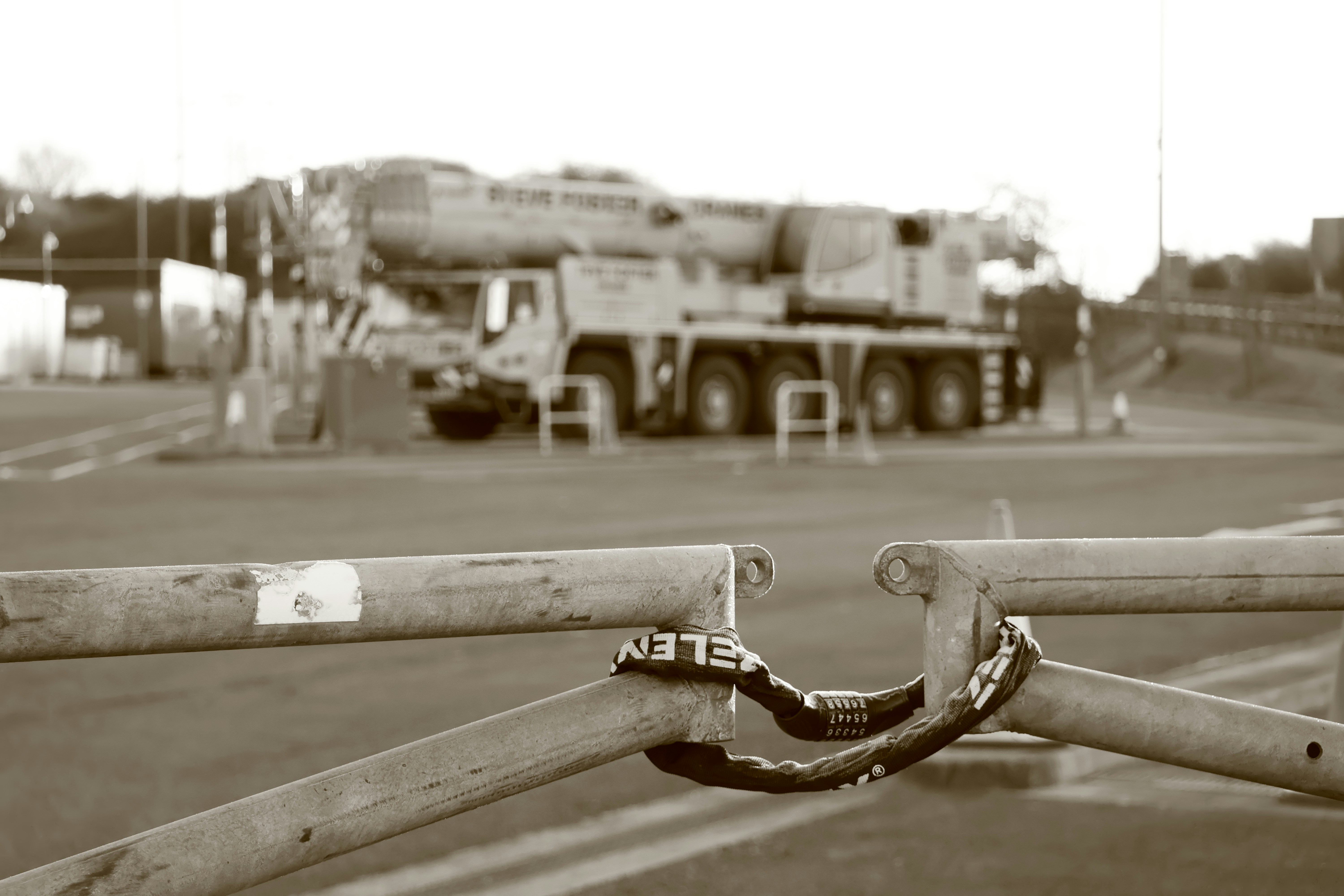 Barrier of Rusted Rails: A Quiet Foreground, Industrial Horizon