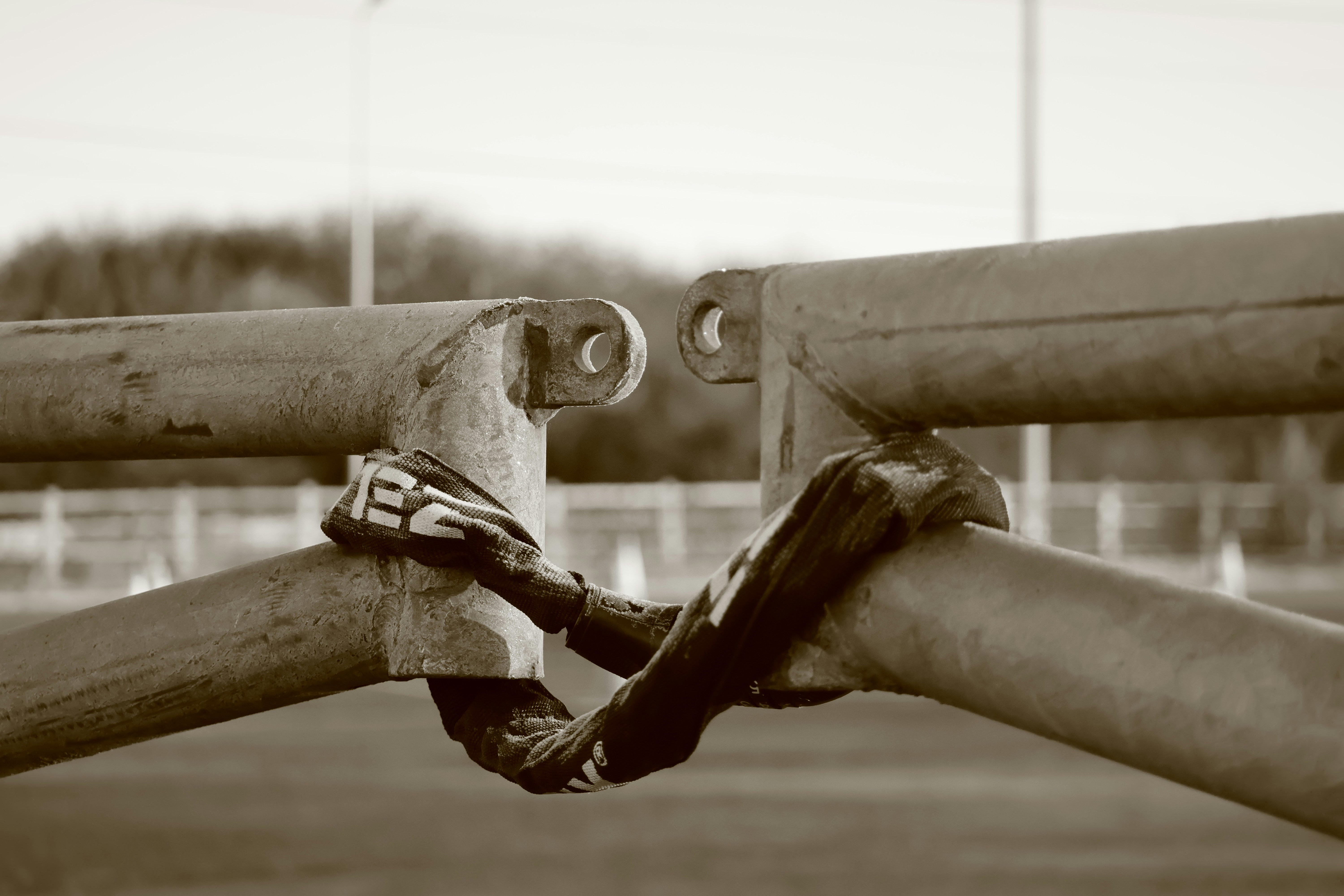 Broken Bond: A Weathered Gate Link in Sepia Silence