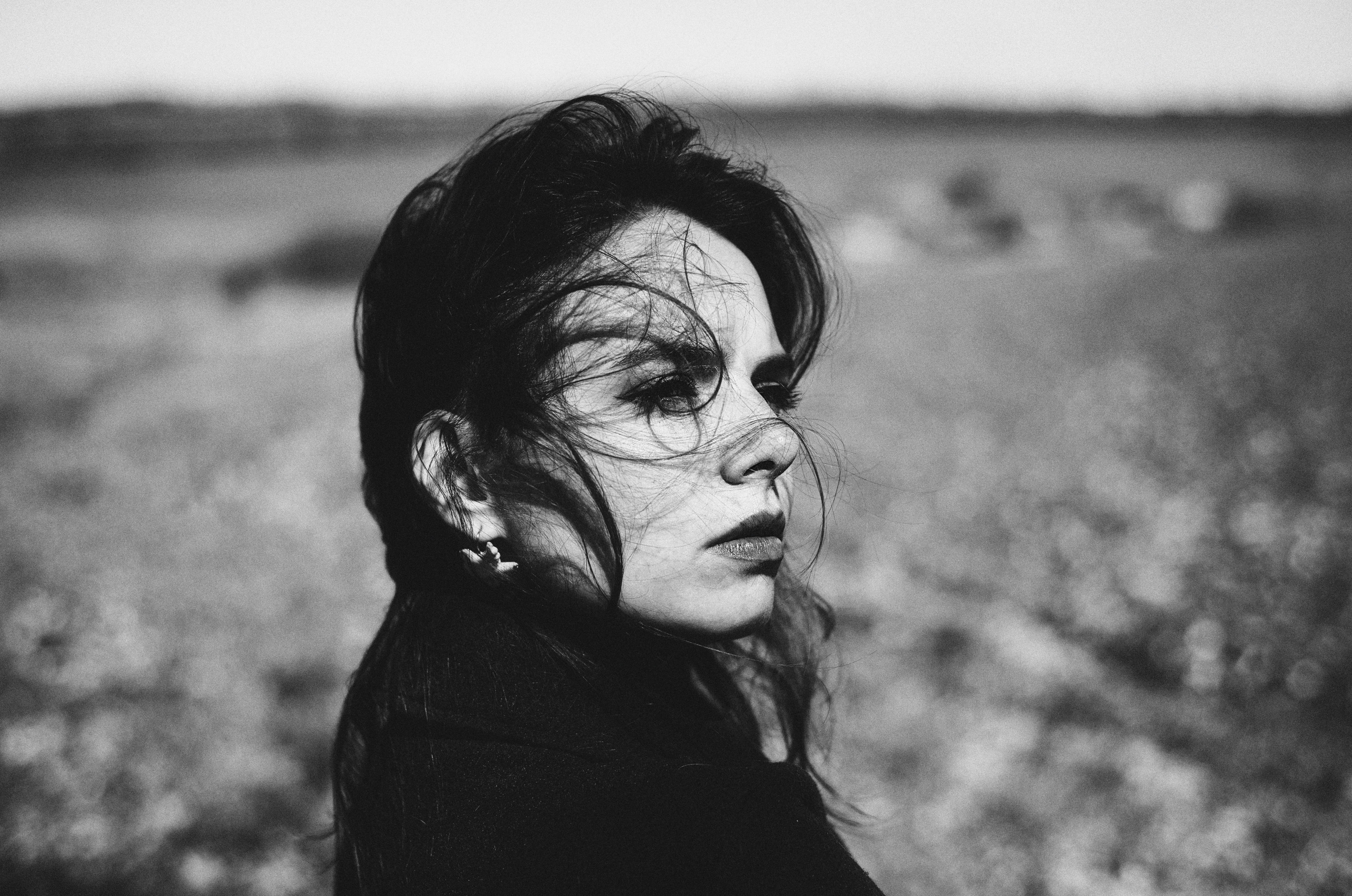Wind on the Face: A Portrait against a Wind-Swept Shore