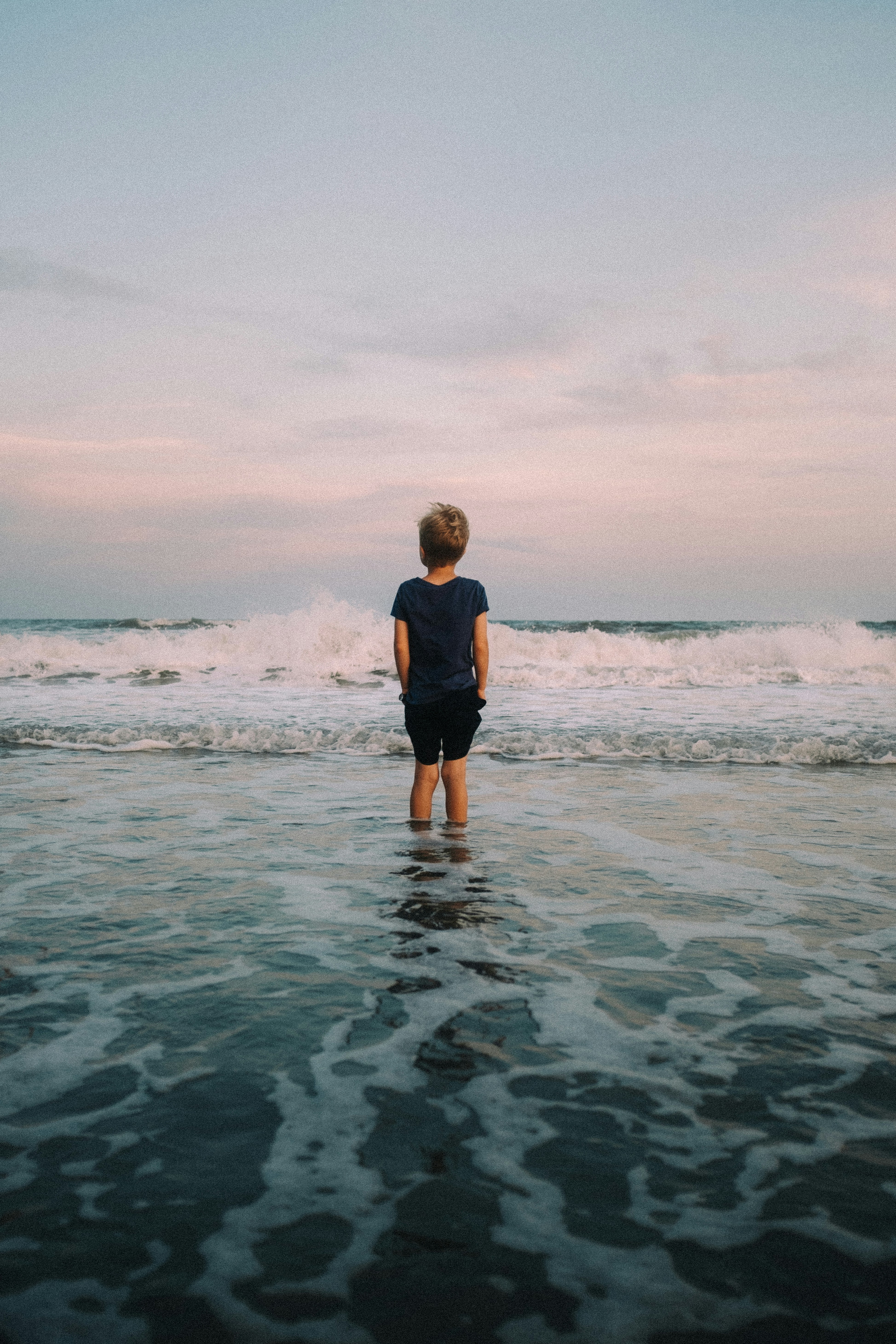Child at the Quiet Edge: A Boy Standing at the Ocean’s Threshold