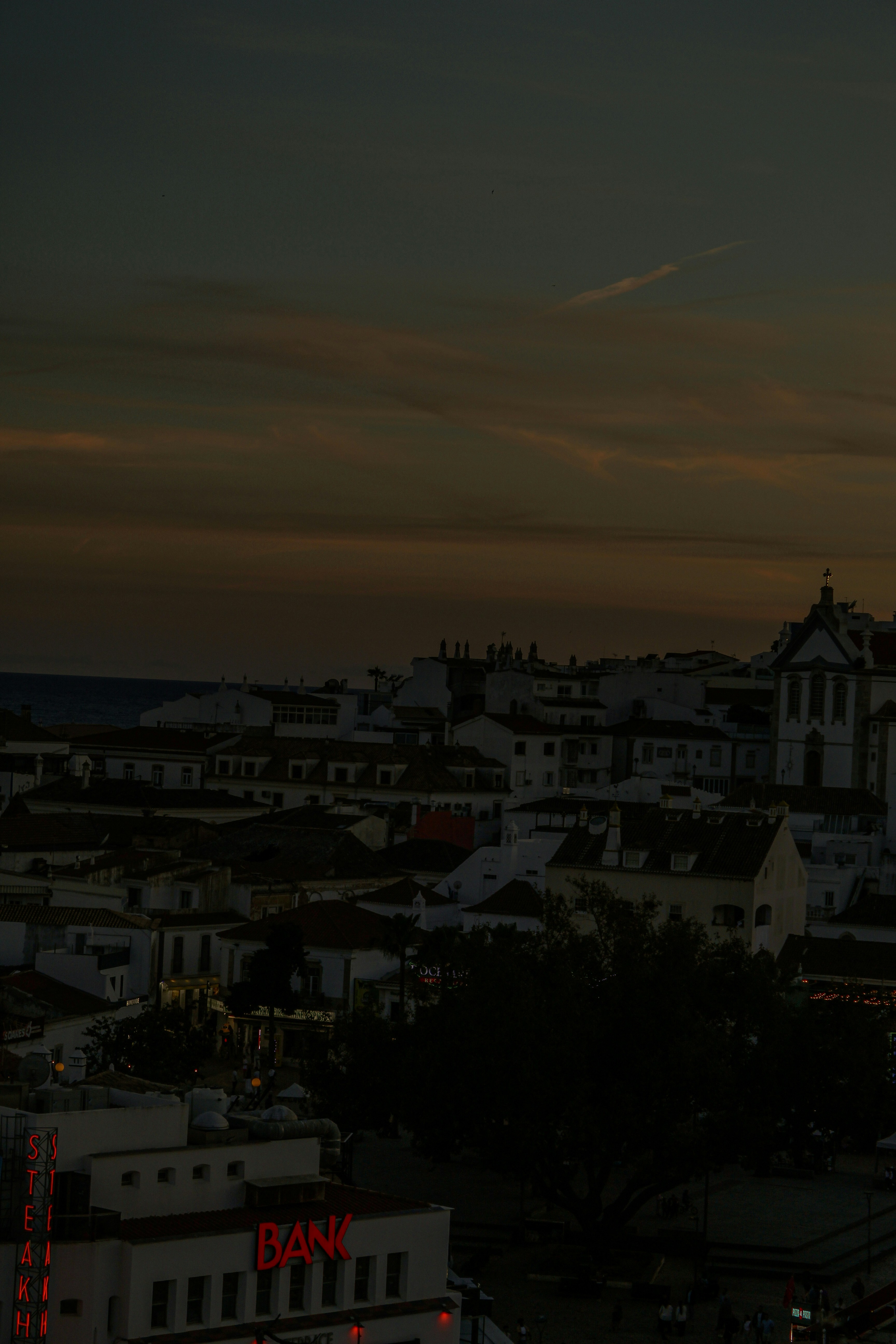 Twilight Over the Pier: A Sunset Cast Over a Quiet Town