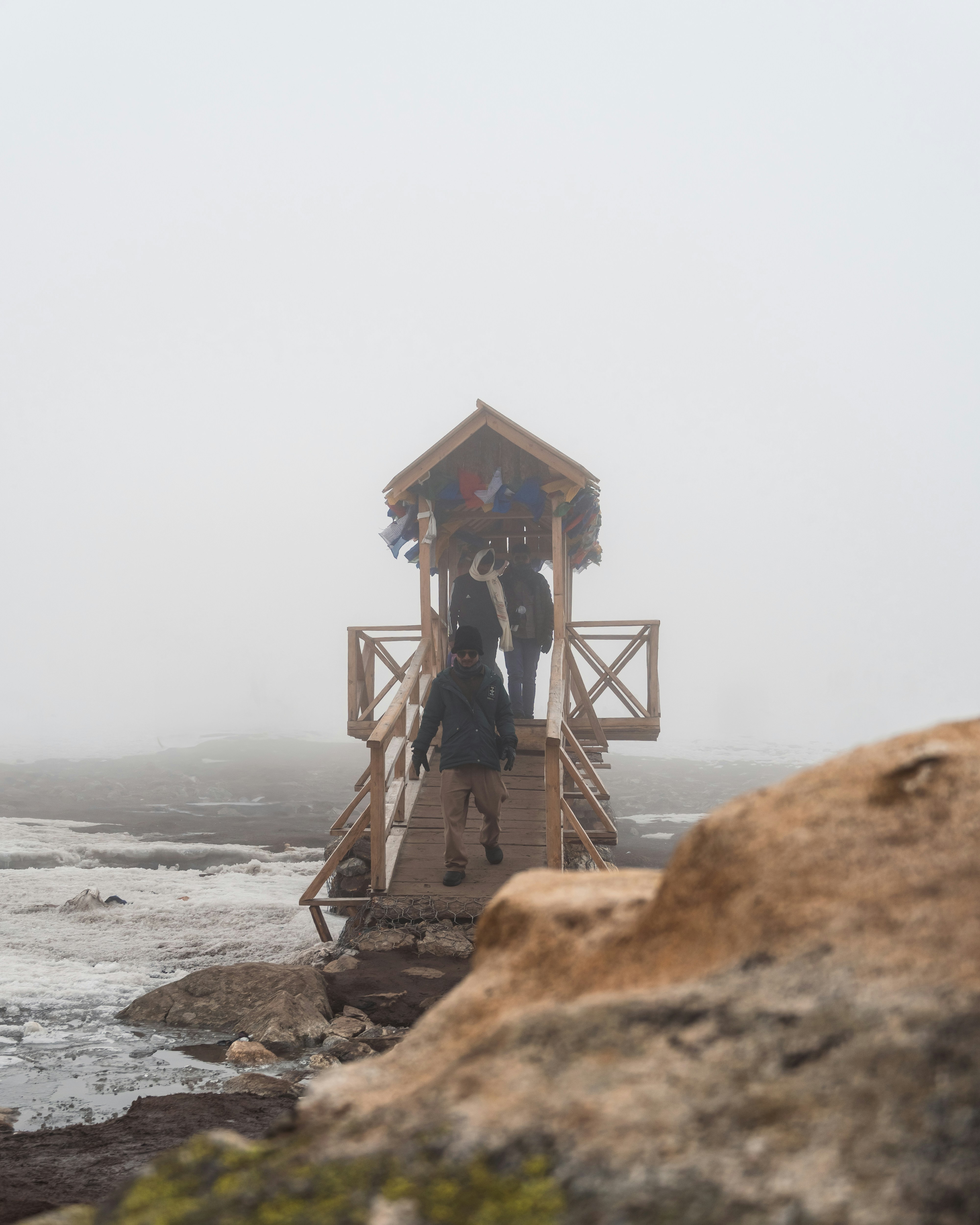Mist-Soaked Lookout: A Lone Figure Faces the Quiet Shrine