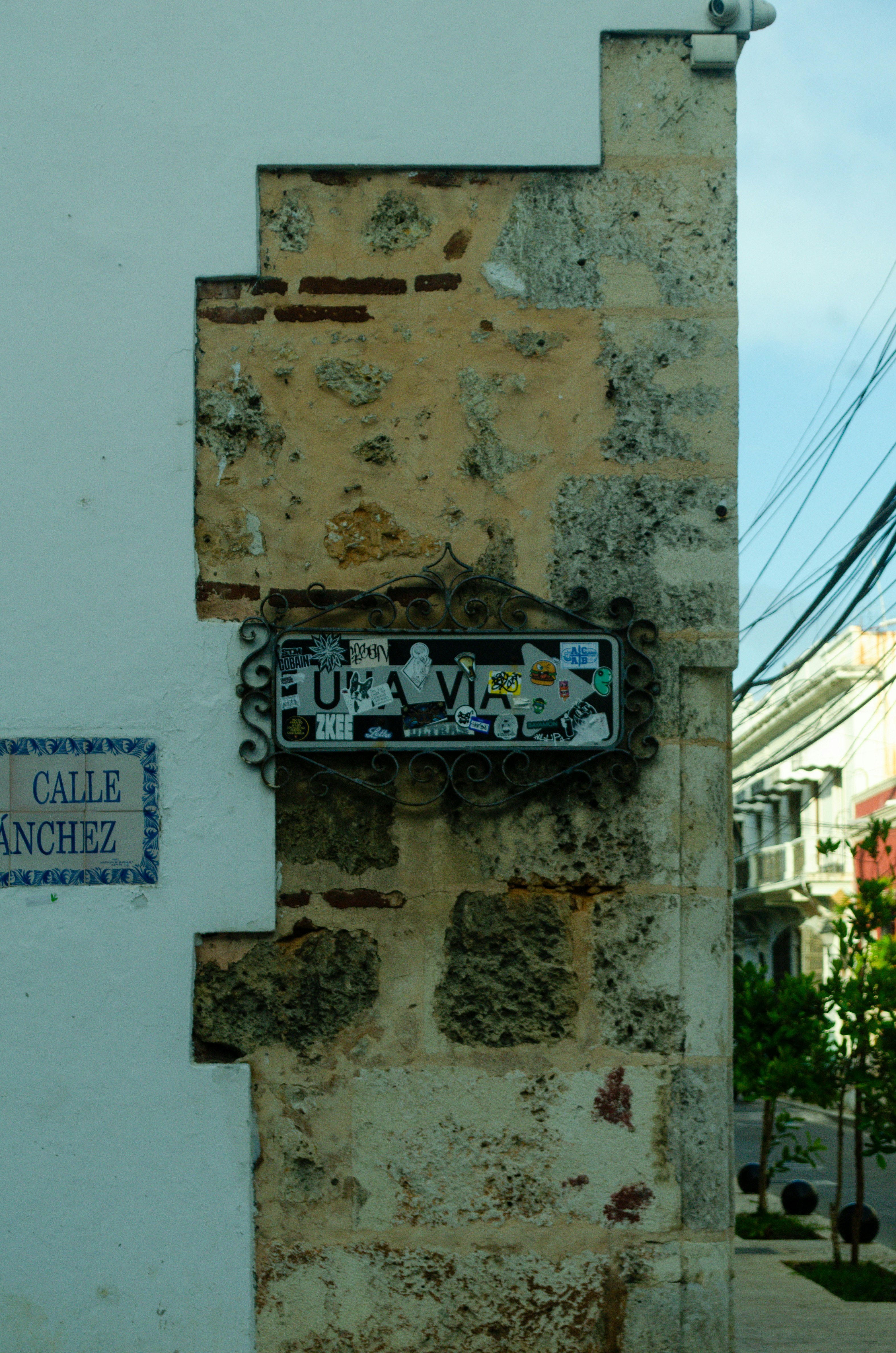Stretched Stone Facade with Weathered Signage in a Placid Street Corner
