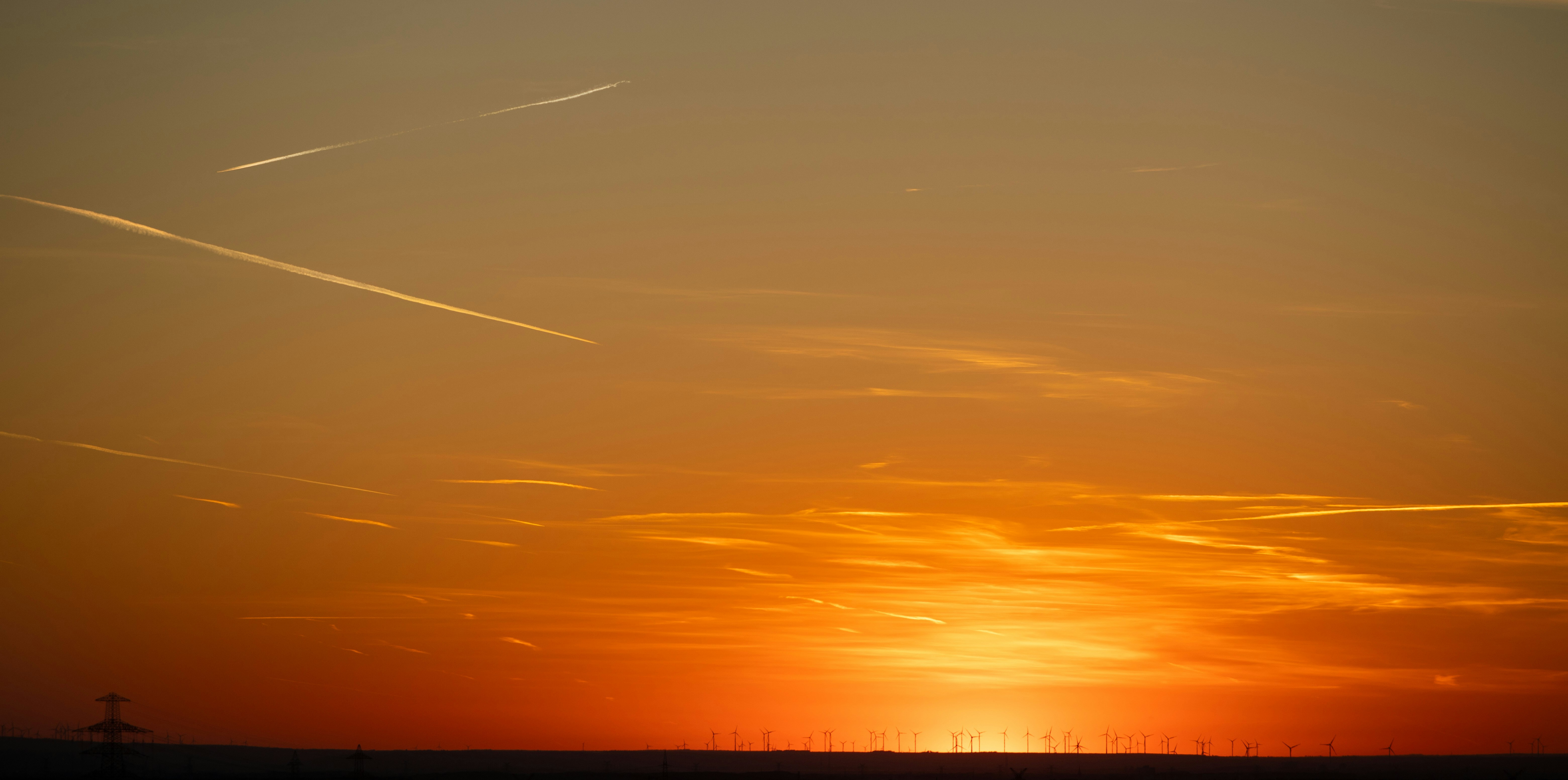Quiet Horizon: Fiery Dusk Over a Calm Flatland