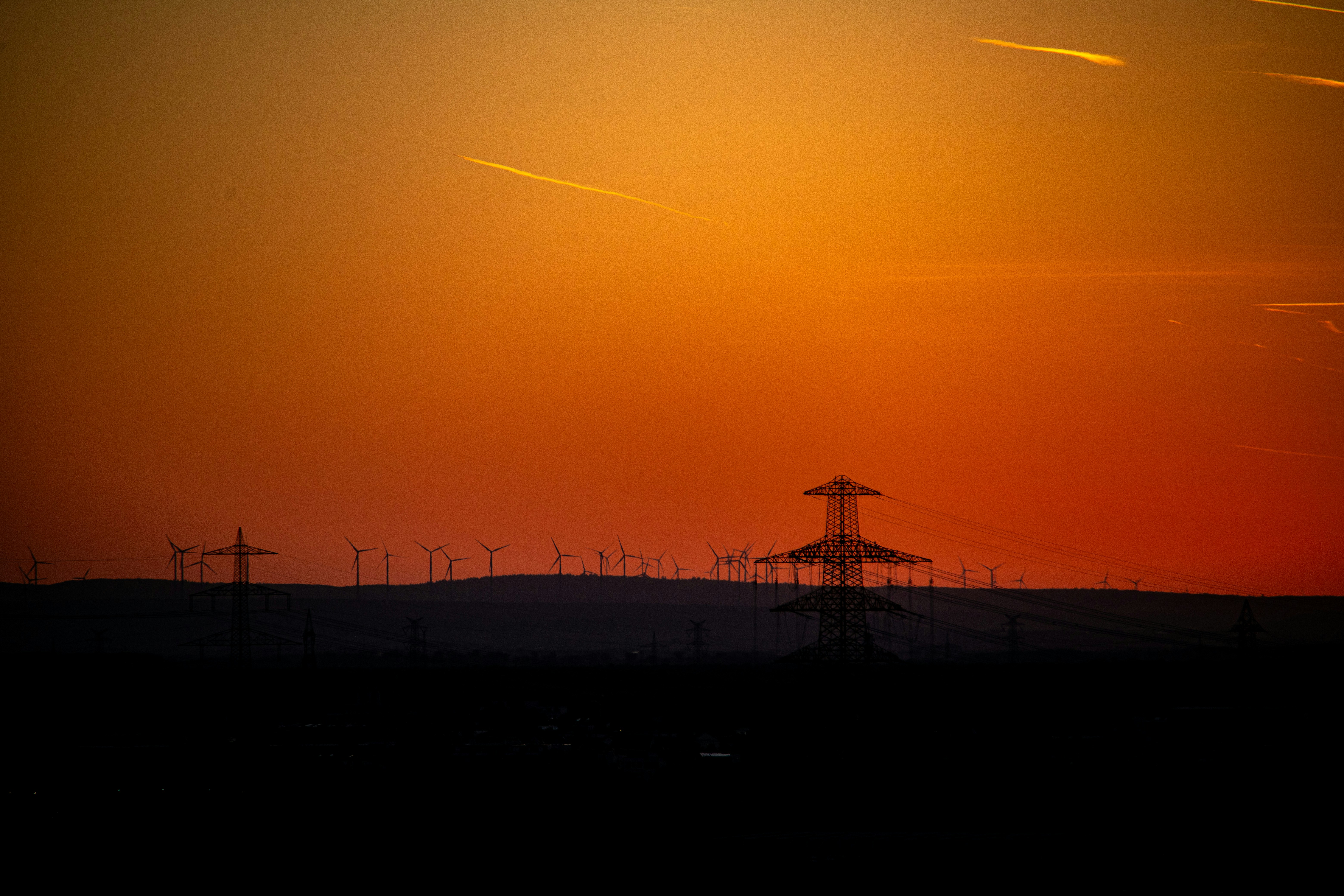 Glowing Horizon: Wind Turbines Silhouetted Against a Fiery Dusk
