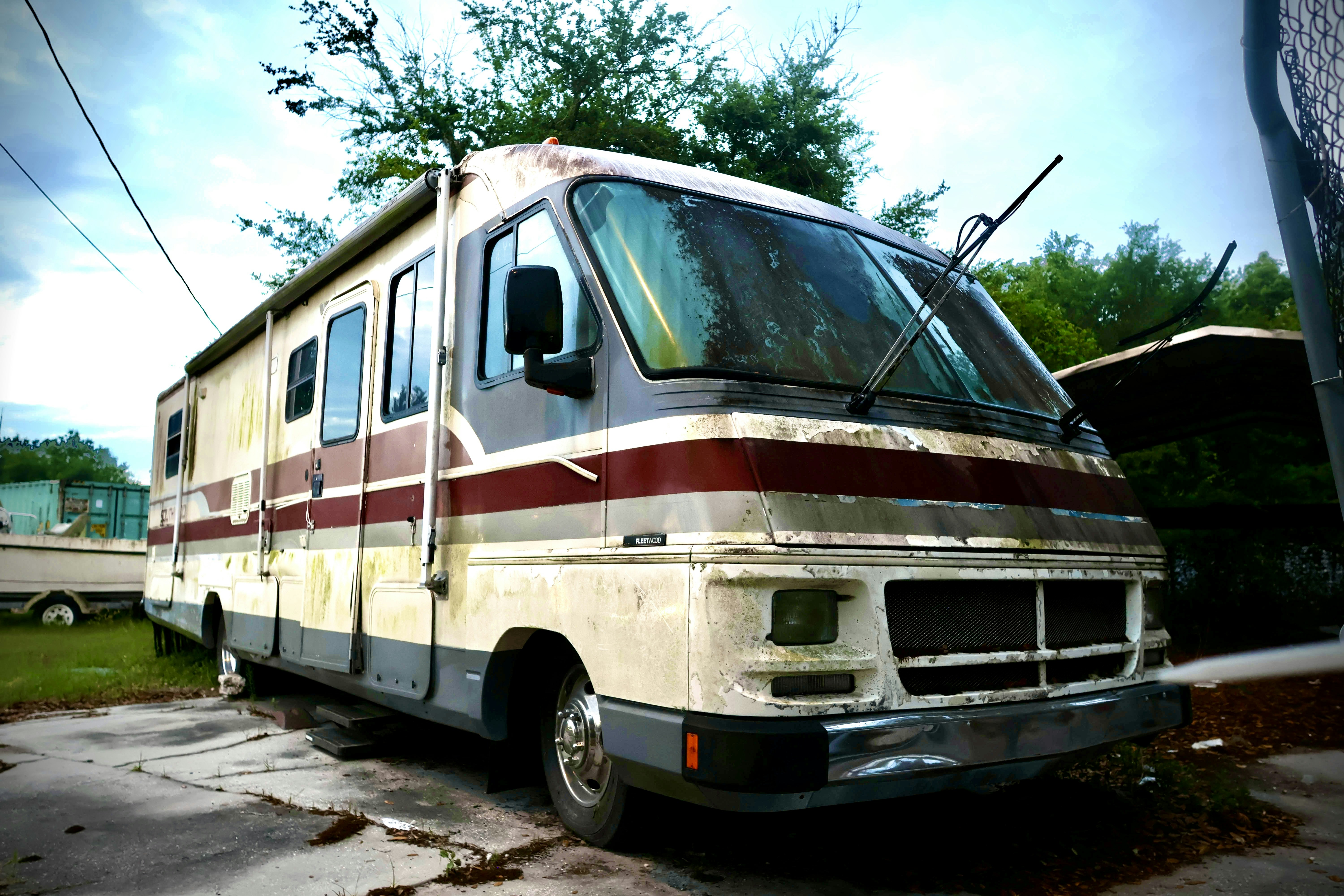 Rusted Wanderer: an old motorhome resting under a stormy sky