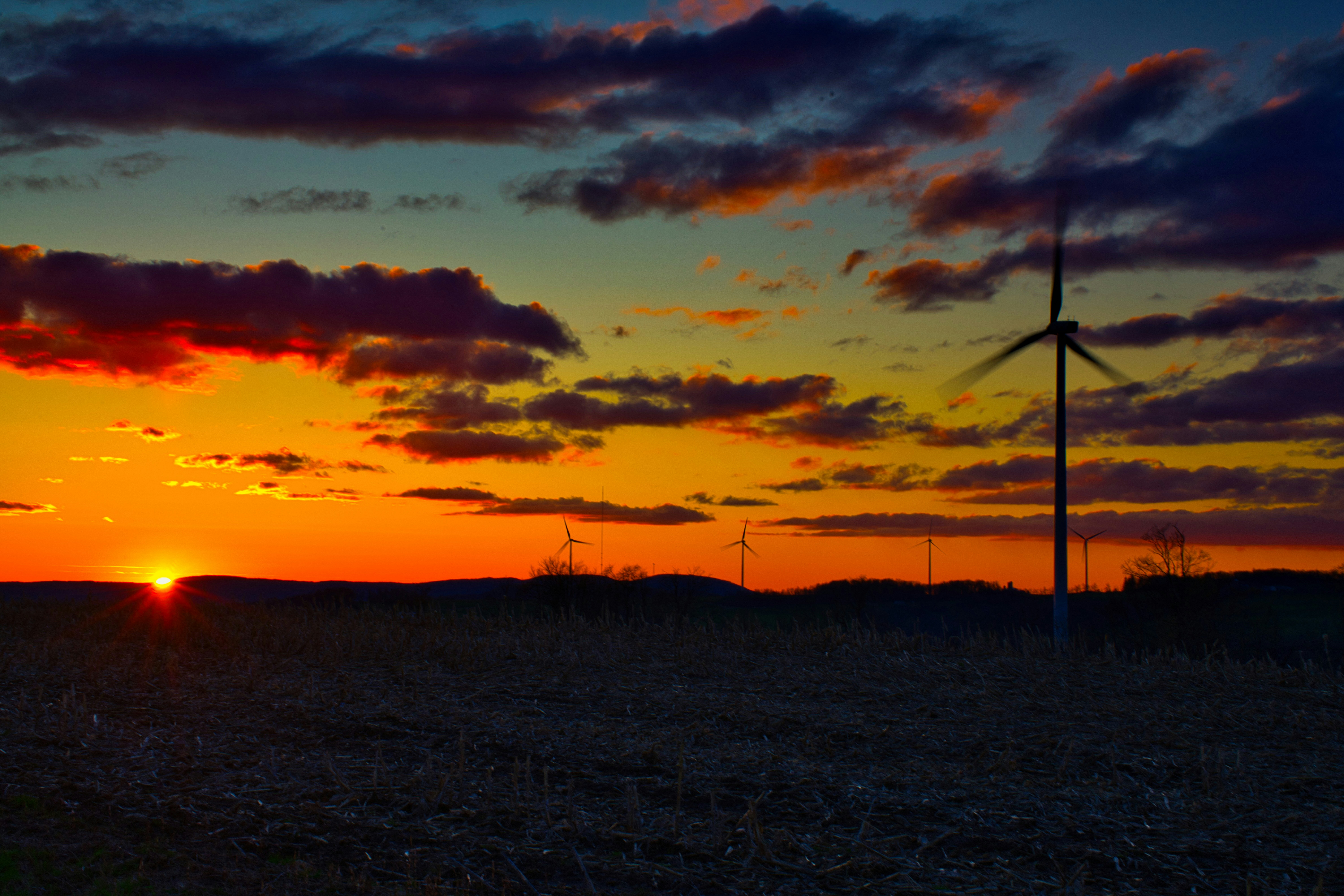 Sunset Windmill Silhouette over a Quiet Plain