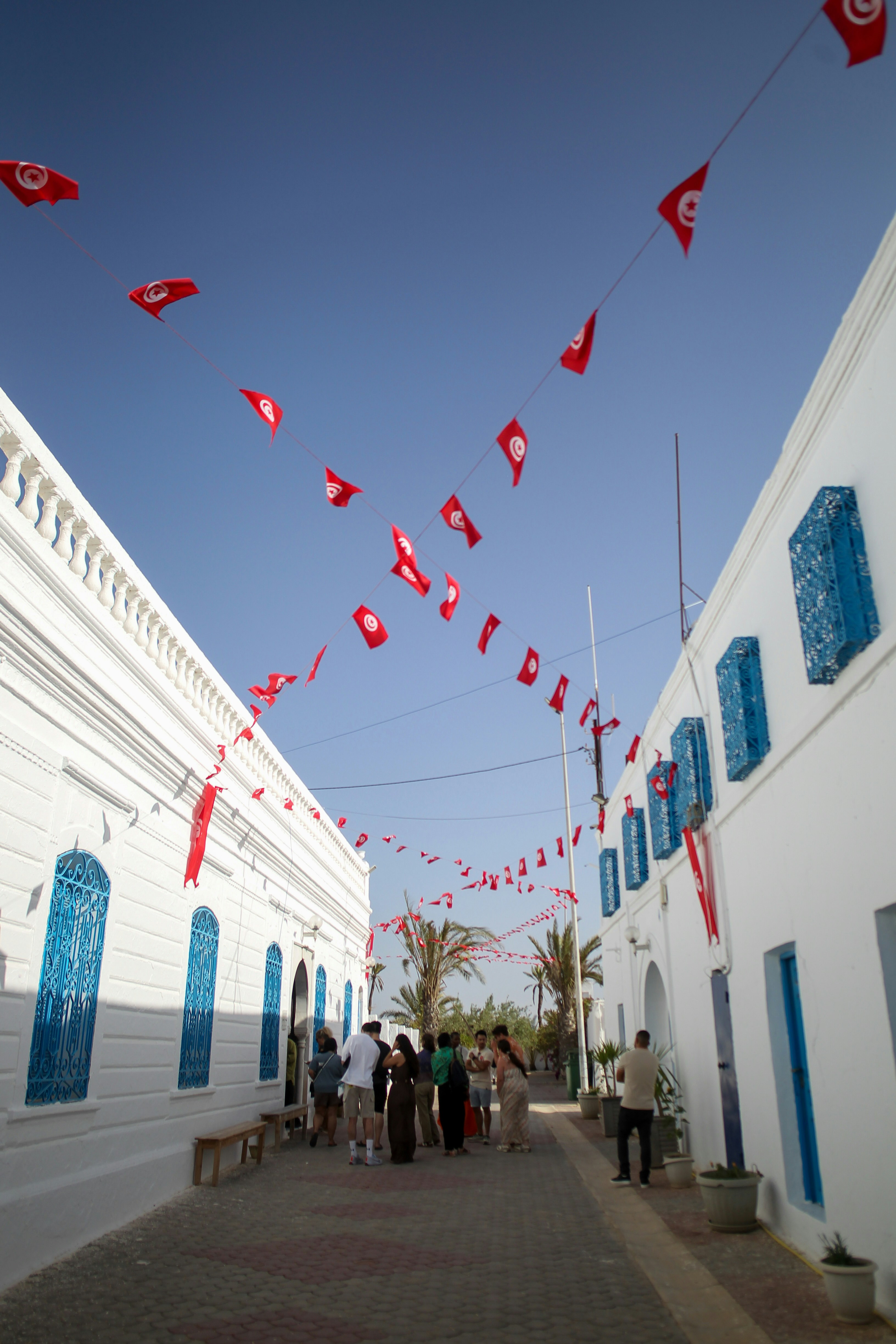 Quiet Tunisian Alley Under a Strung Flagscape
