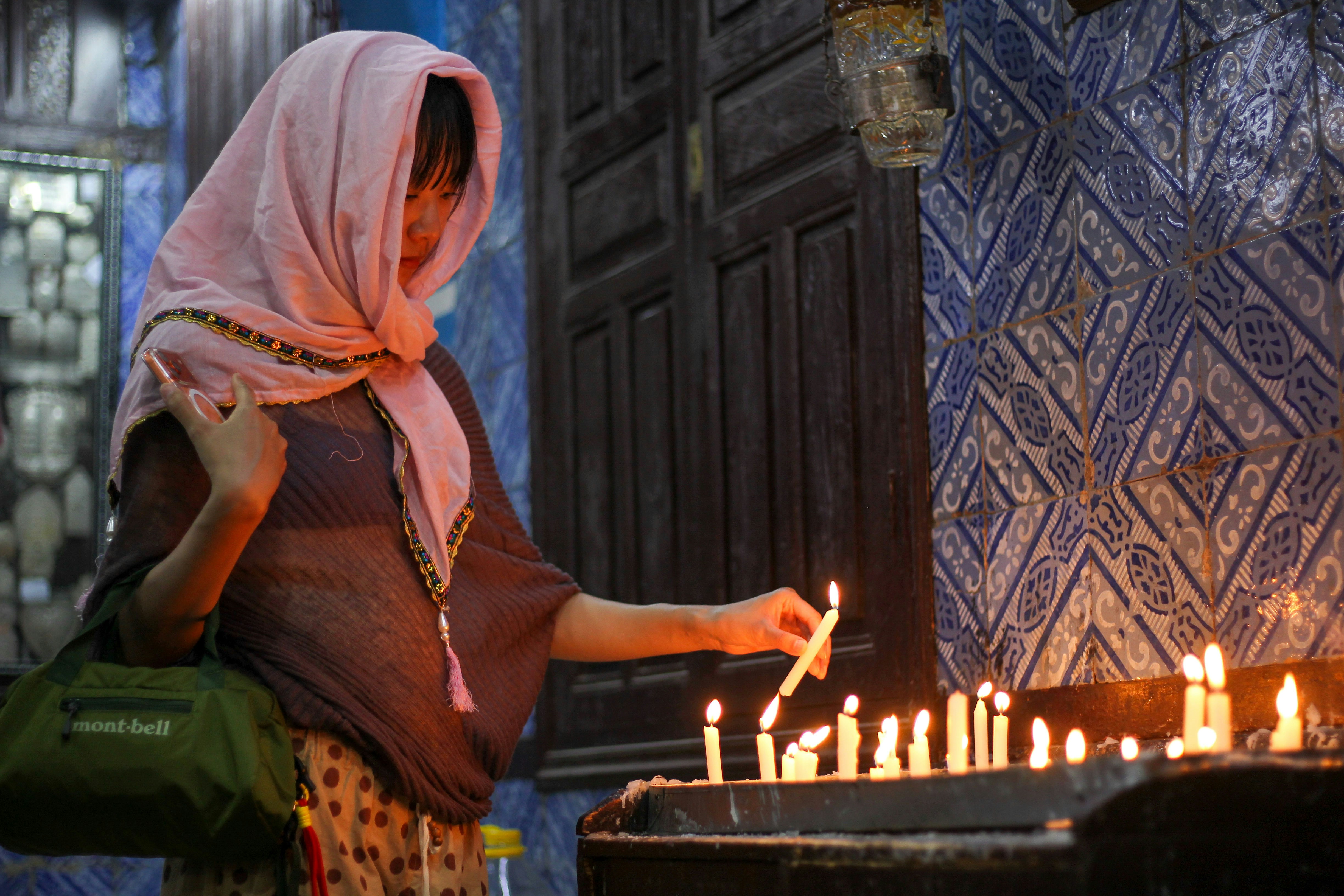 Candles and Quiet Faith: A Woman Tends to the Flame