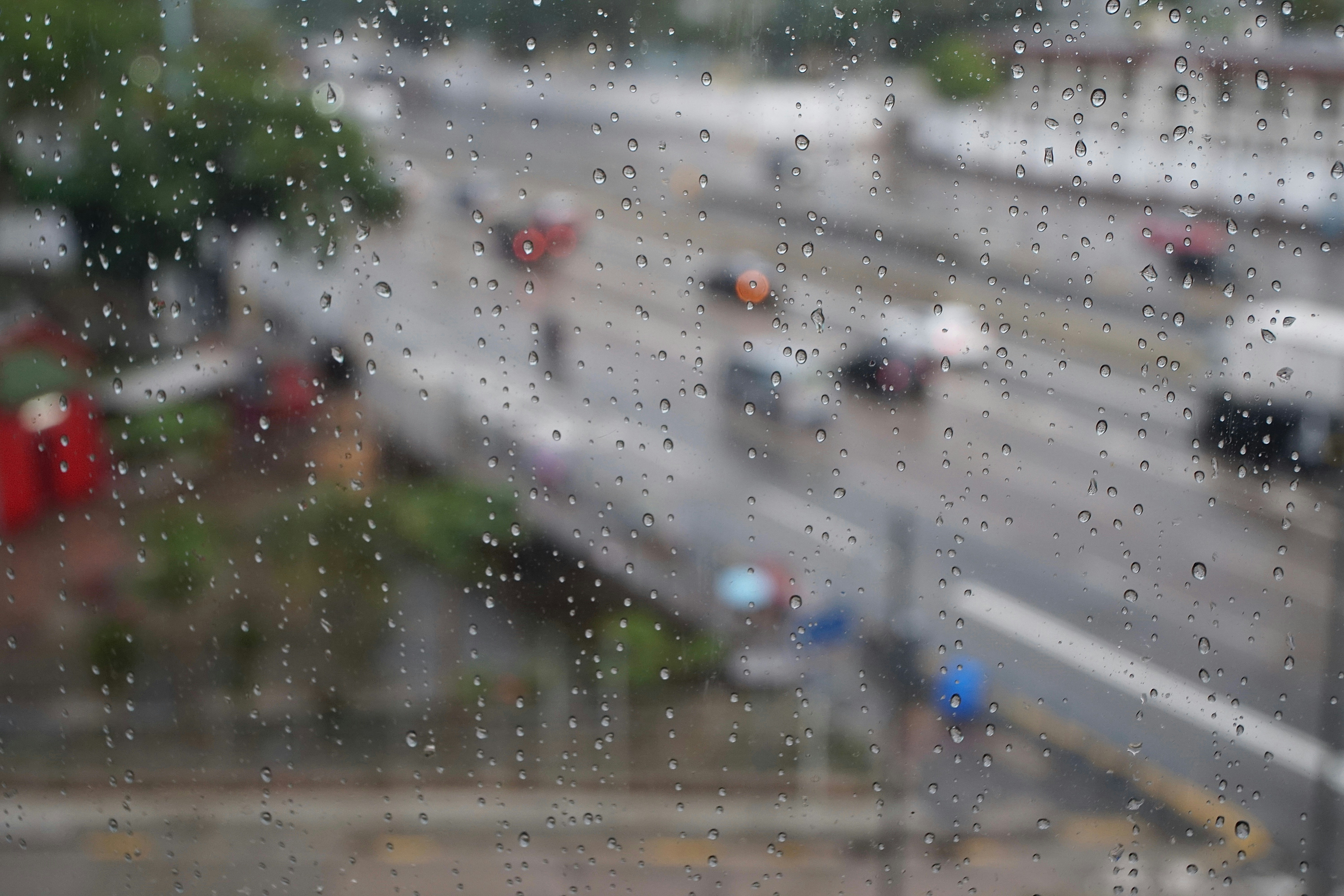 Rain-streaked Window with Blurred Urban Motion