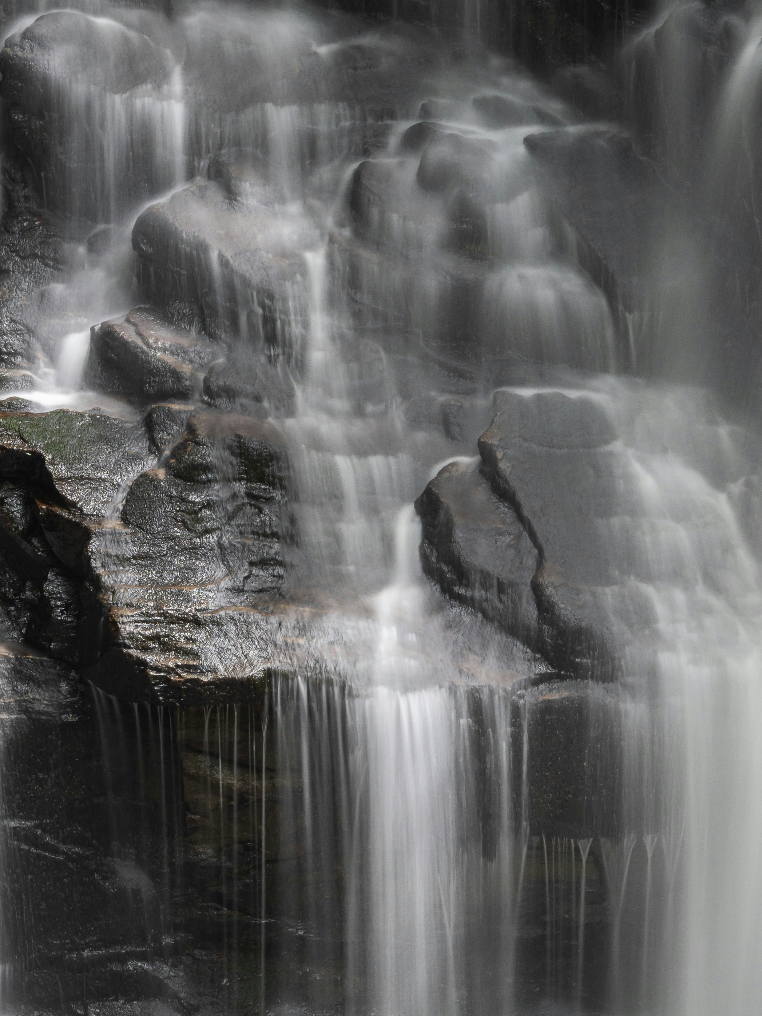 Veiled Cascade: Soft Locks of Water over Basalt Steps