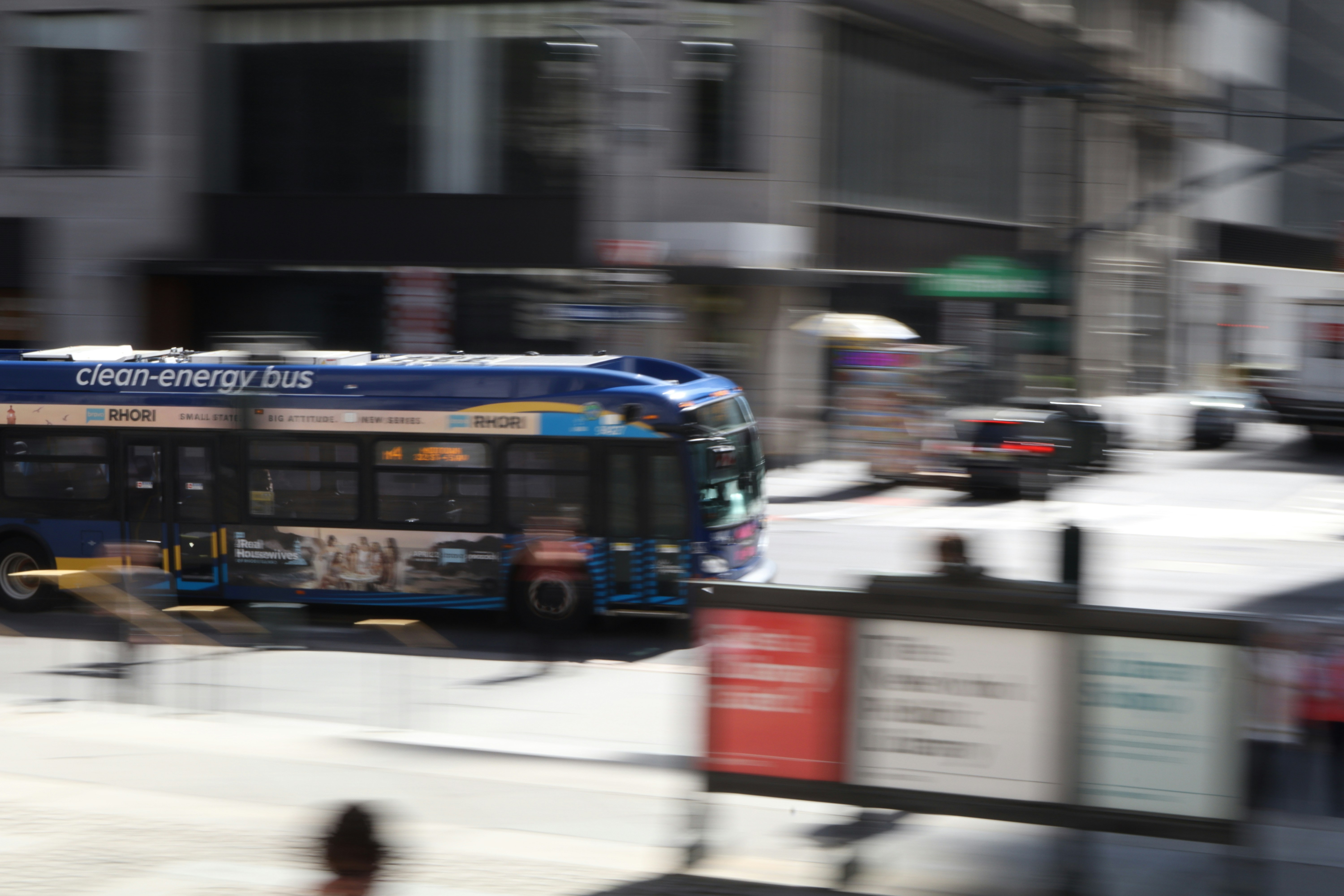 Blurry City Transit in Motion: A Blue Bus in a Quick Pan
