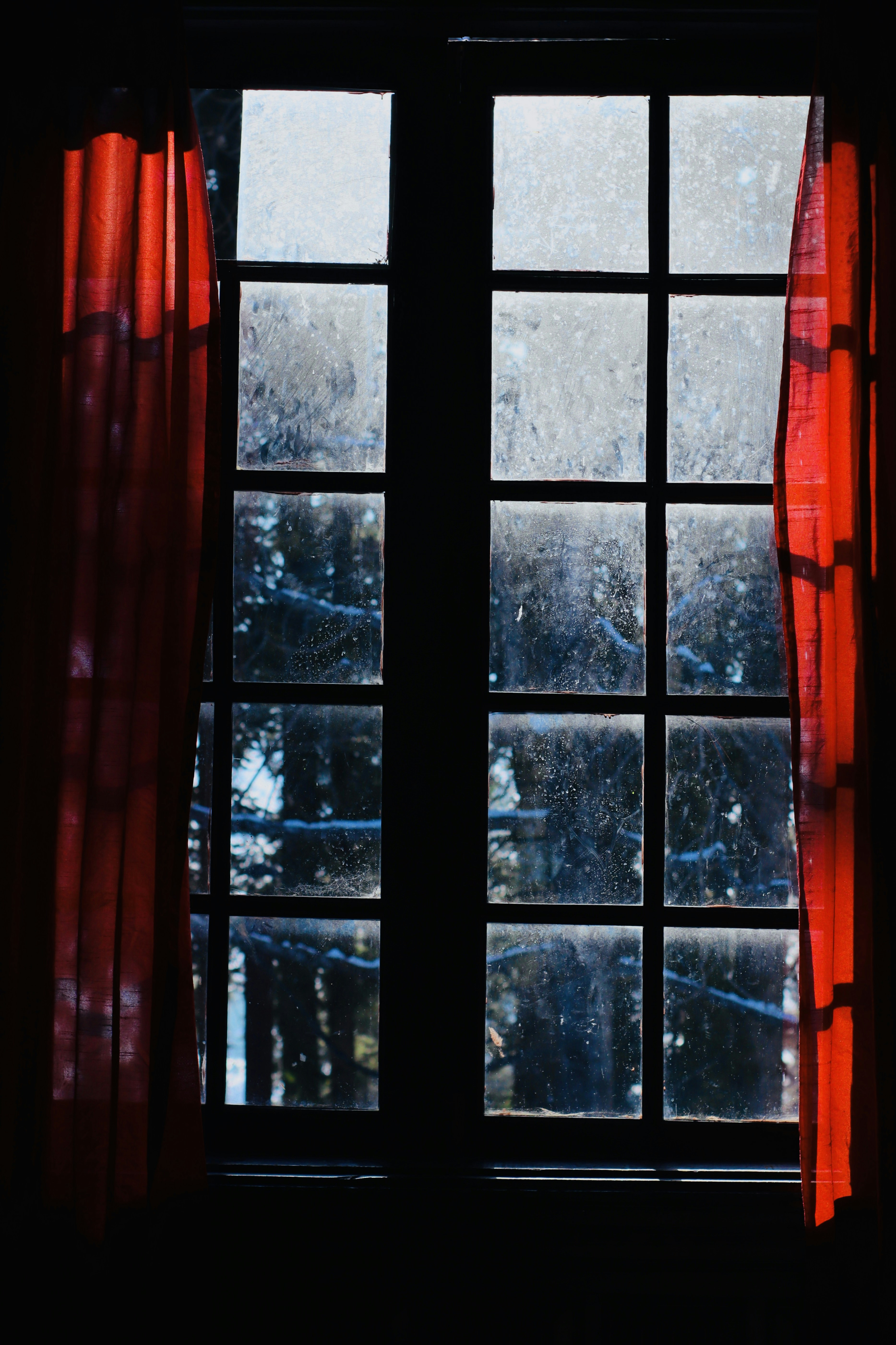 Crimson Drapes Framing a Frosted Window