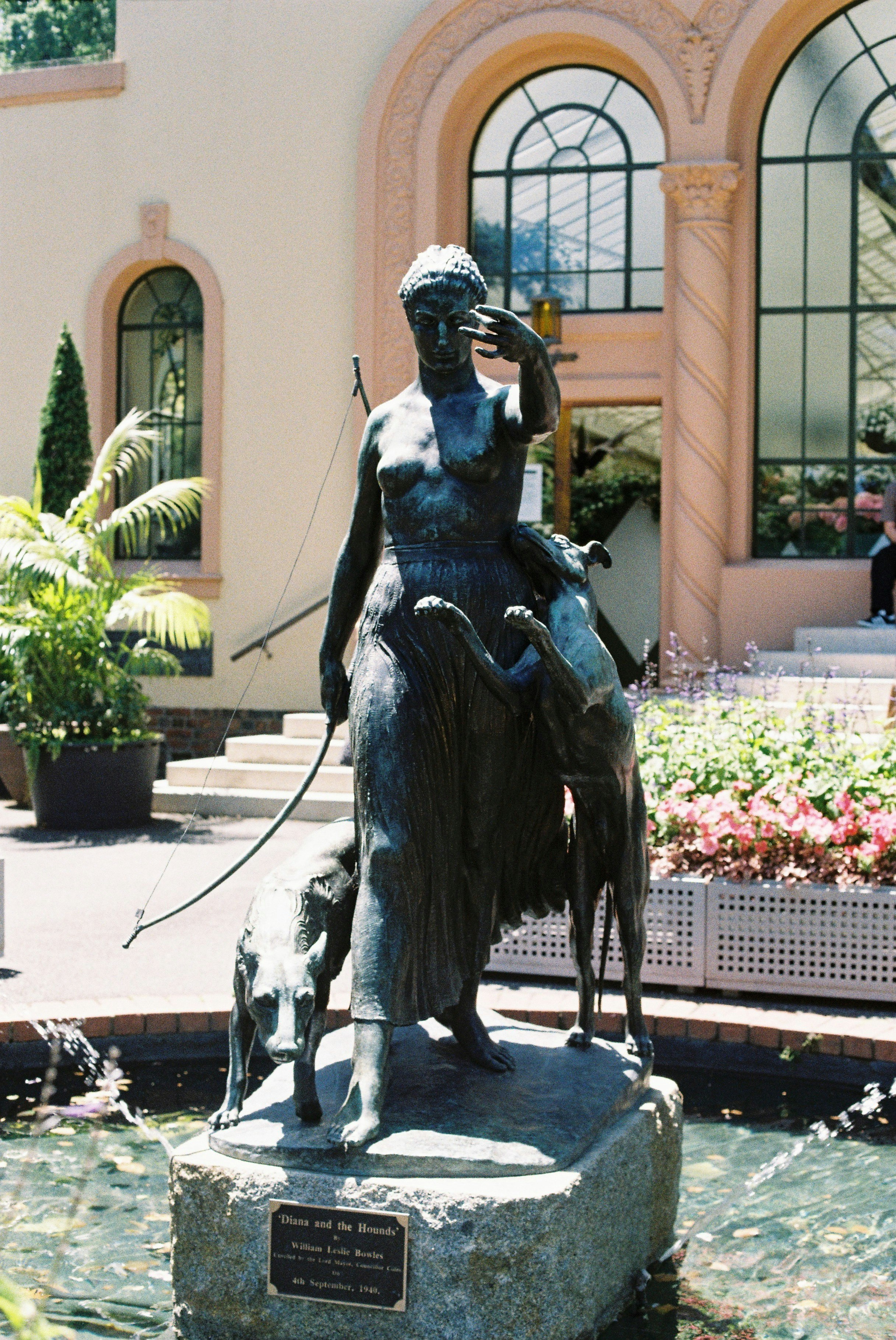 Statue of Figures by a Fountain in a Sunlit Courtyard