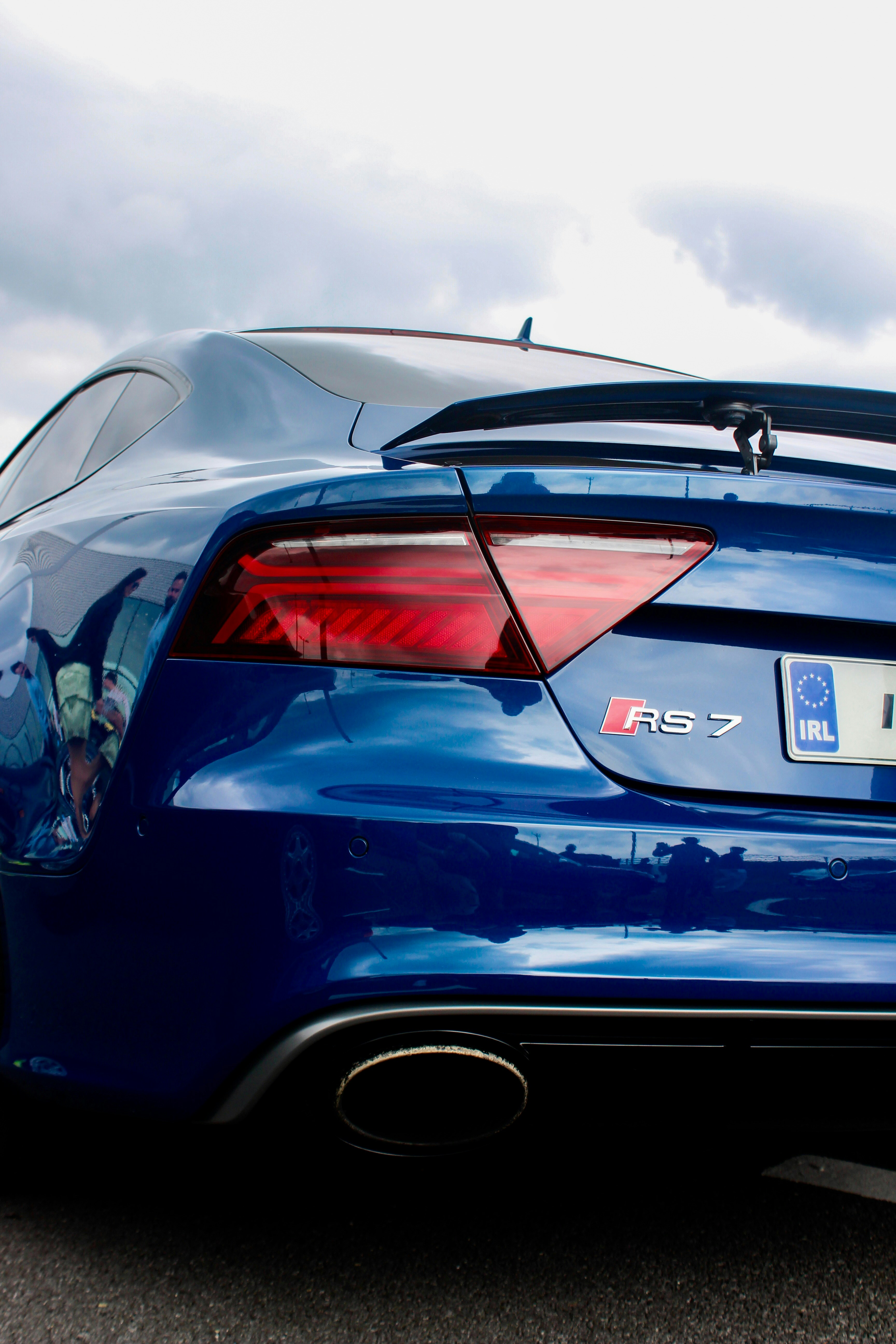 Blue RS 7: a rear-quarter glare and sport trim under overcast skies