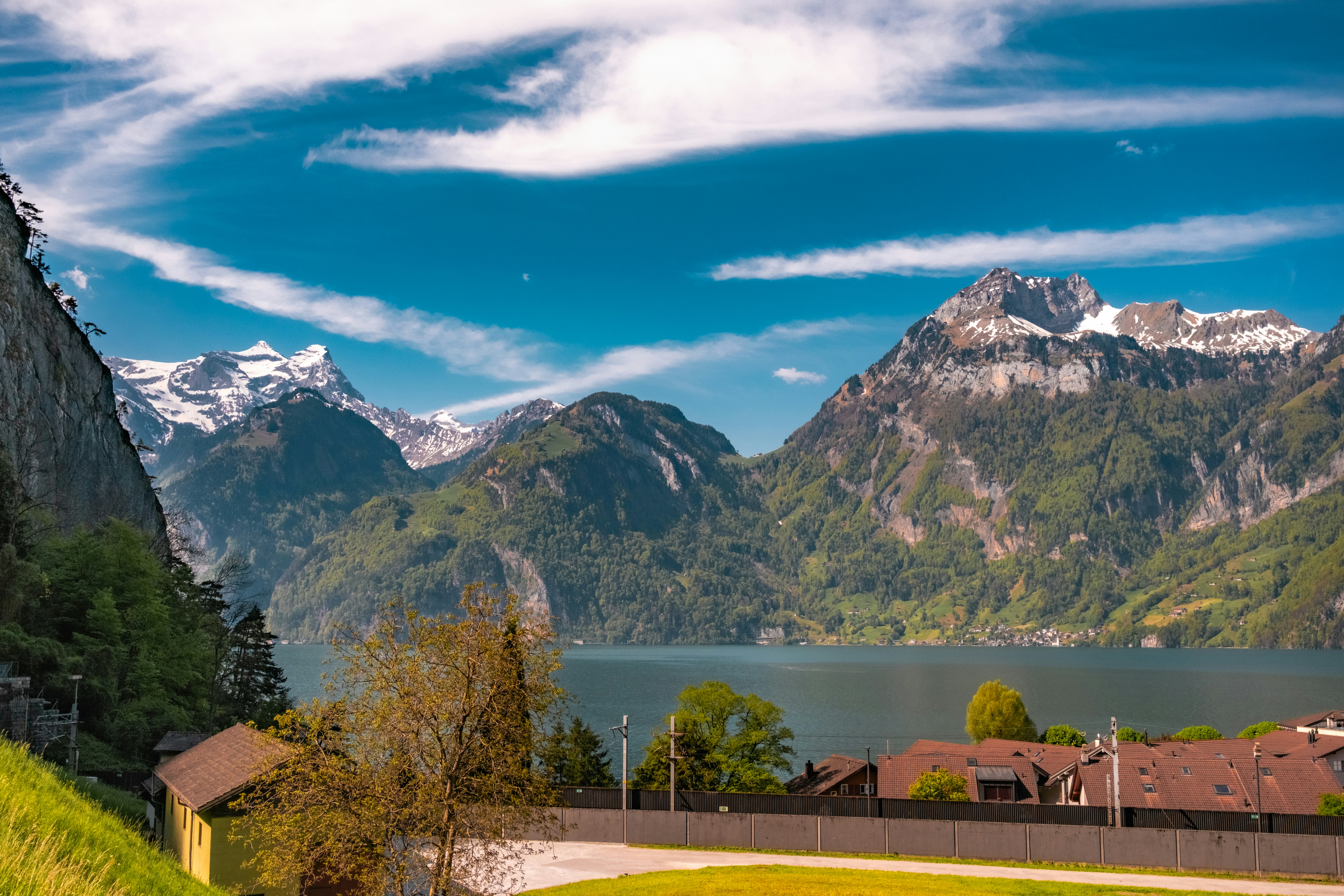 Sunlit Alpine Village by a Serene Lake