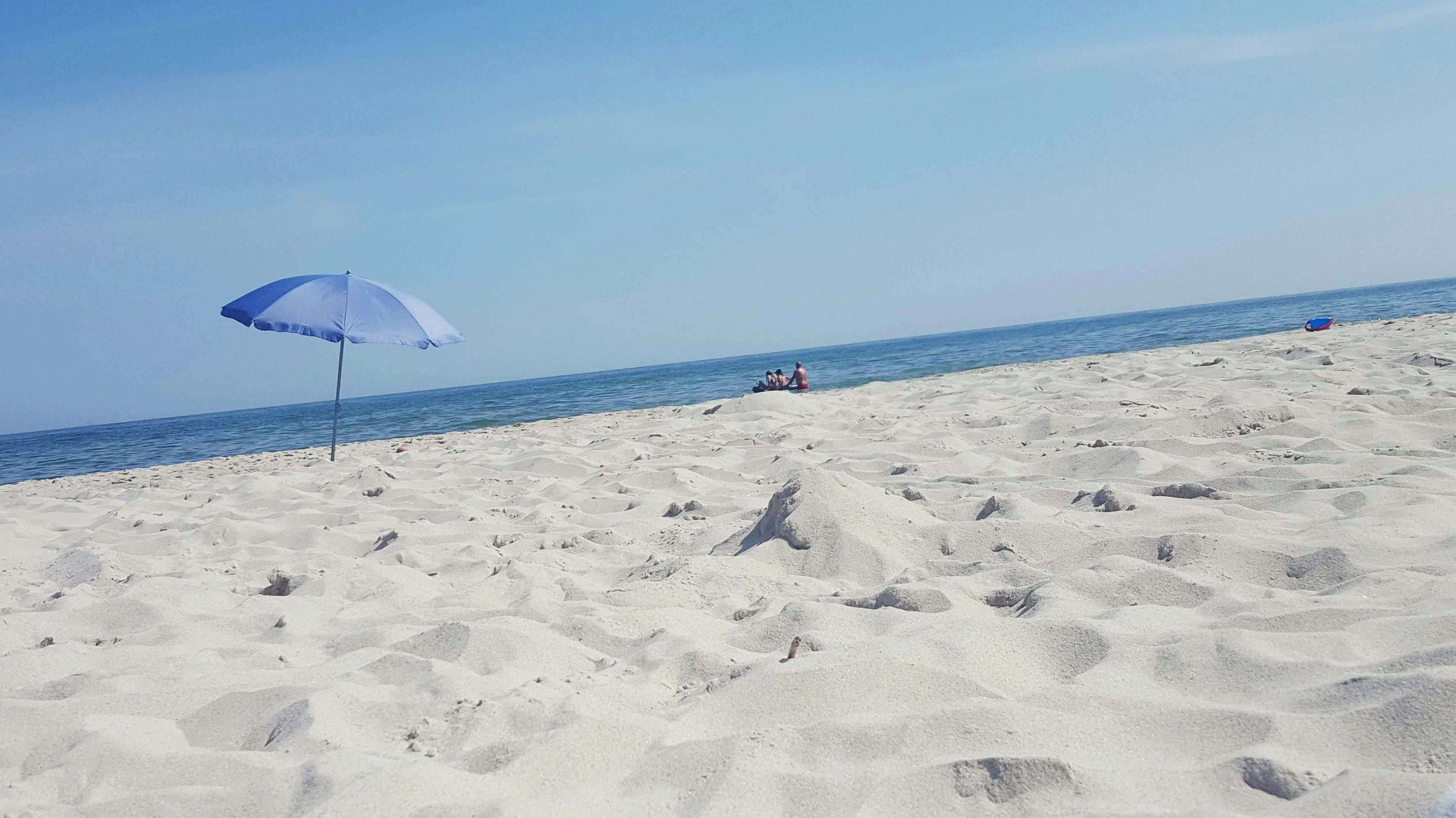 Blue Umbrella on Quiet Spring Shore