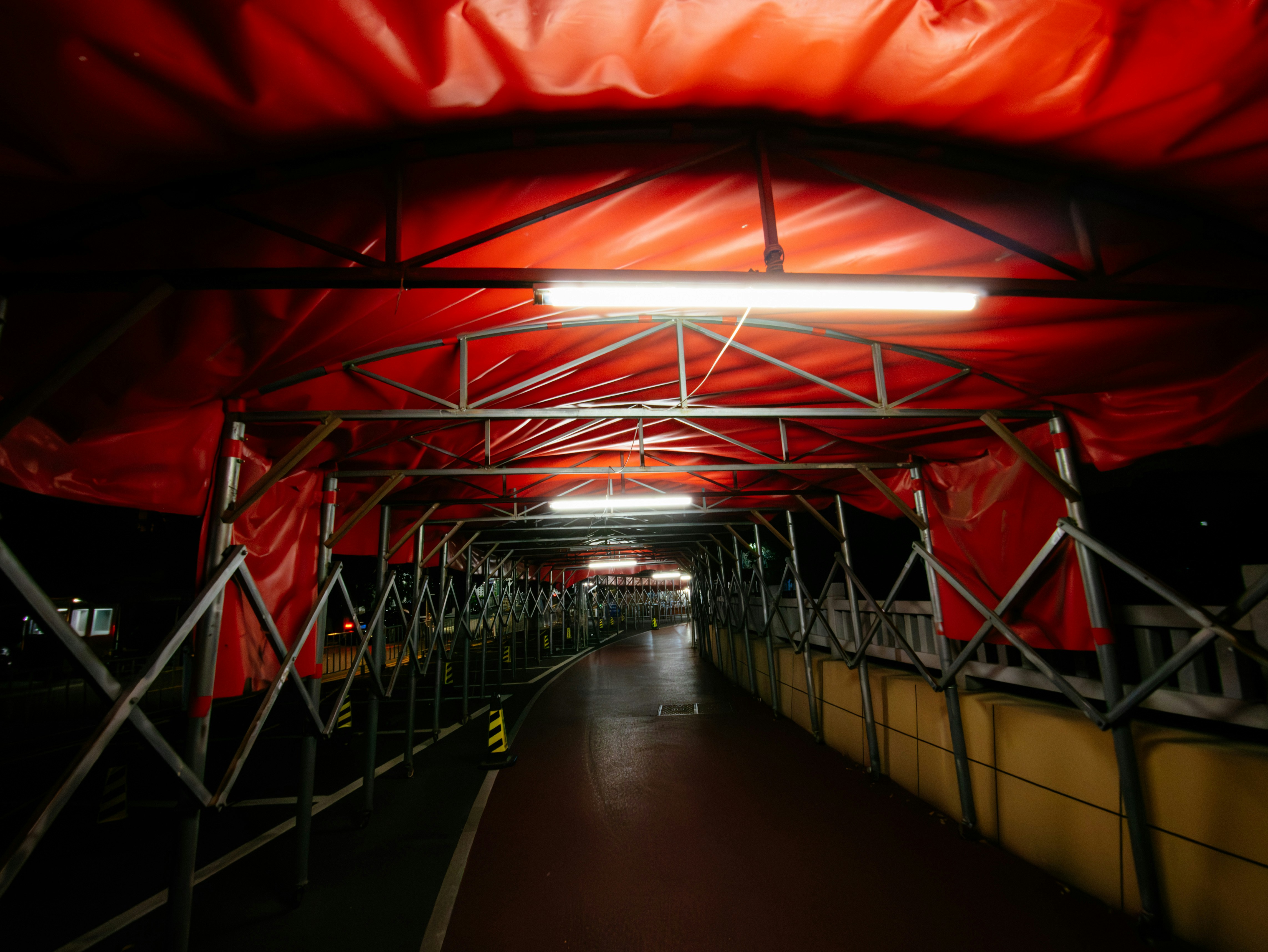 Under the Red Canopy: A Concrete Corridor toward the Unknown