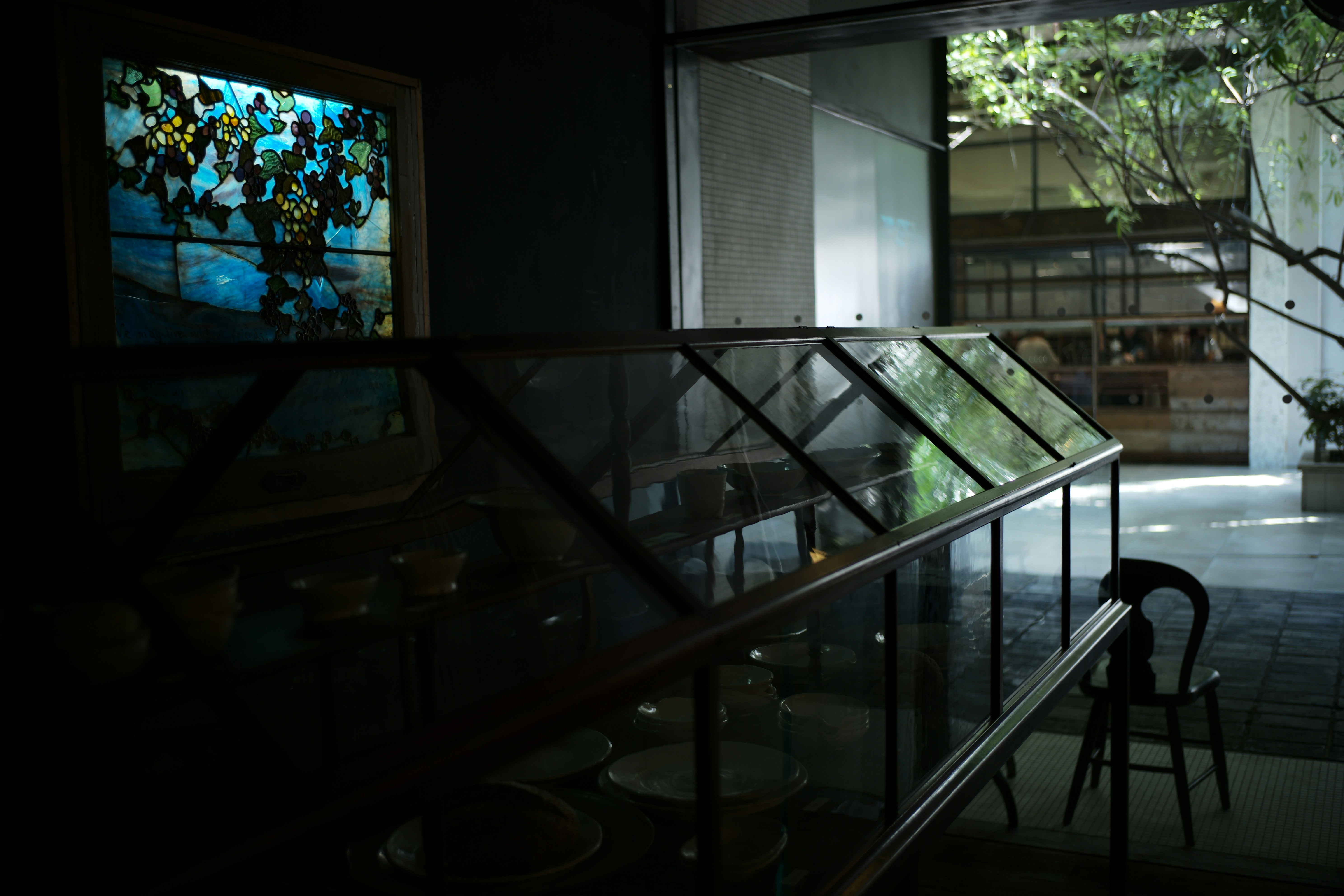 Dim Café Corridor With Glass Railing and Framed Artwork