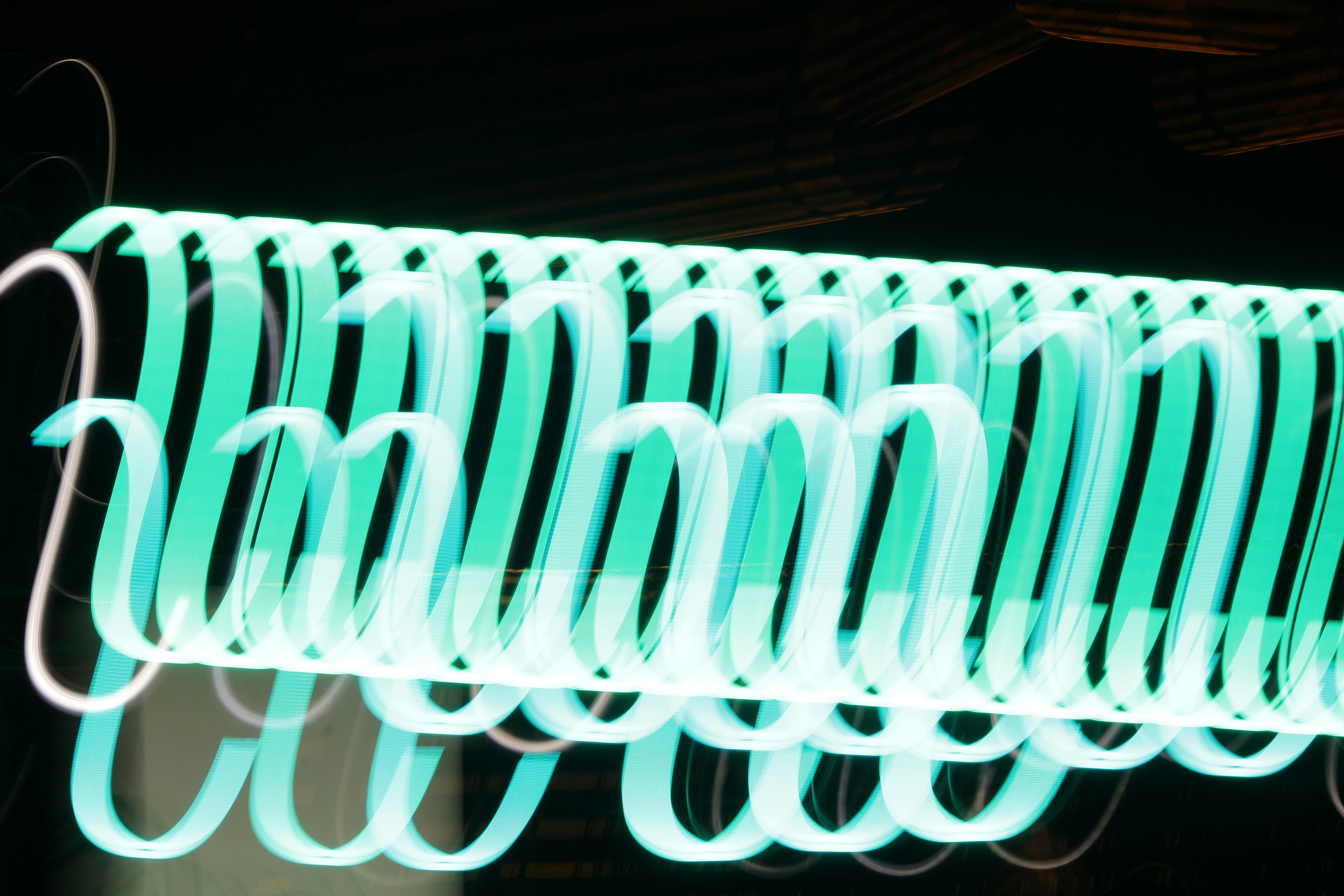Neon Helix: A Long-Exposure Dance of Mint Light