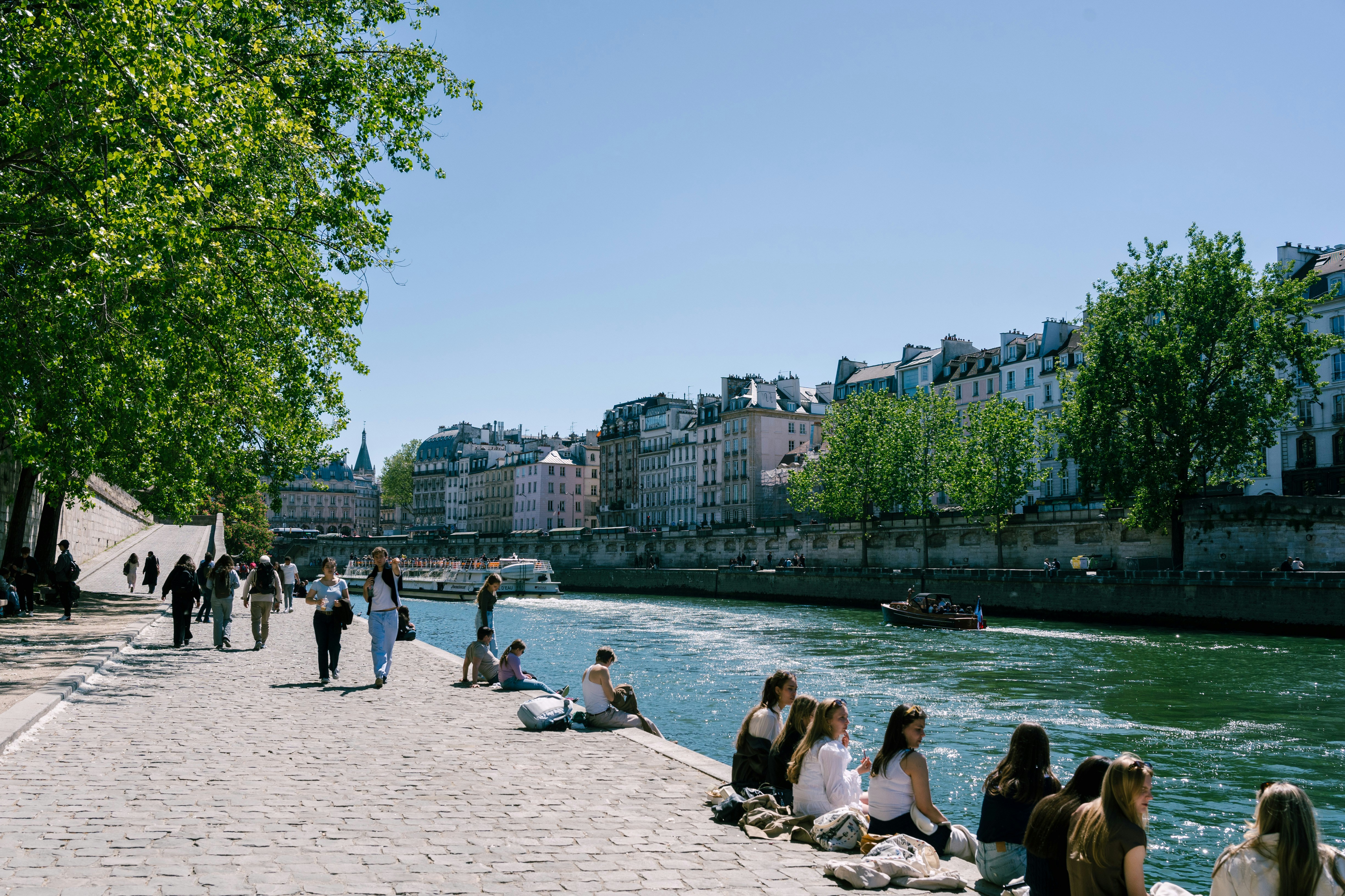 Riverside Stroll Along a Sunlit European Promenade
