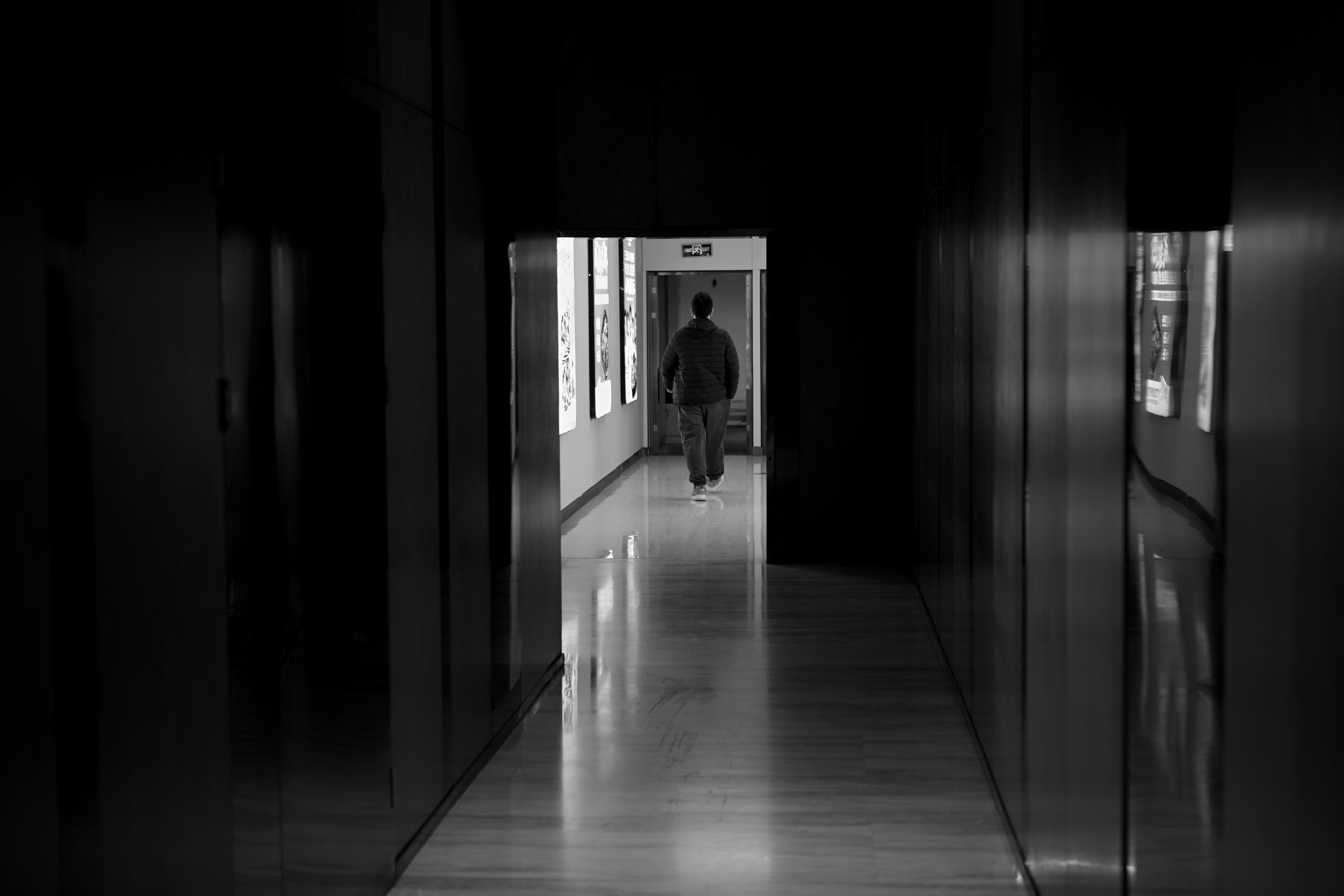 Silent Threshold: A Lone Figure Reaches the Light