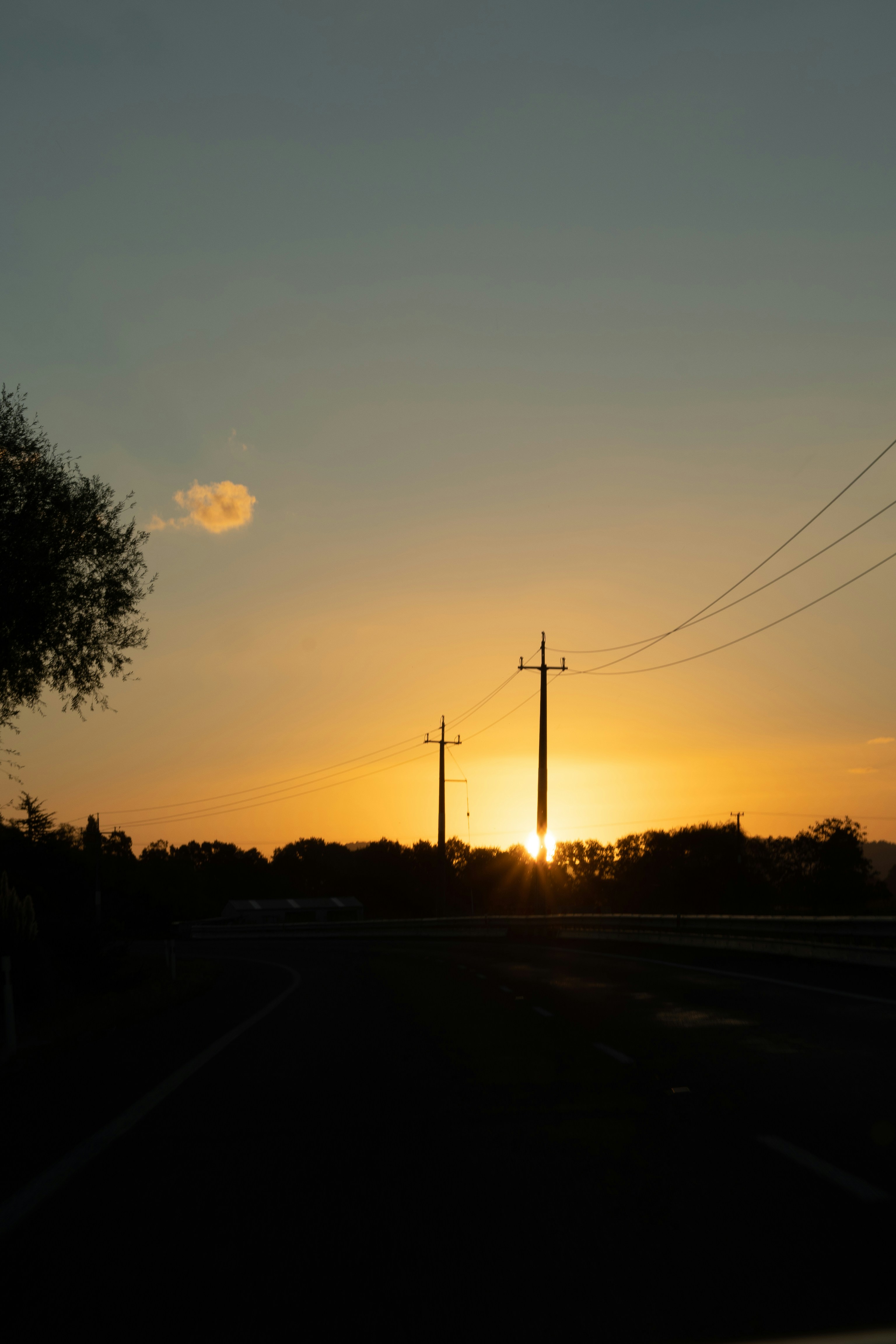 Sunlit Lanes: Power Lines Framing a Quiet Horizon at Dusk
