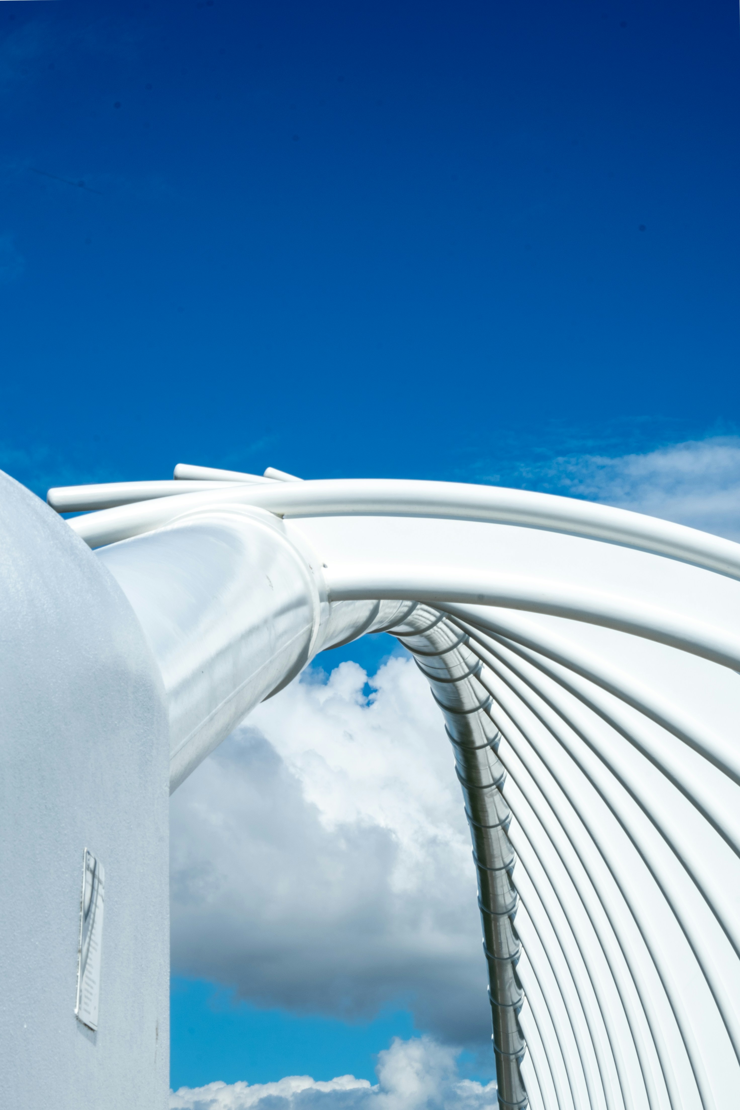 Curved White Arches Against a Clear Blue Sky