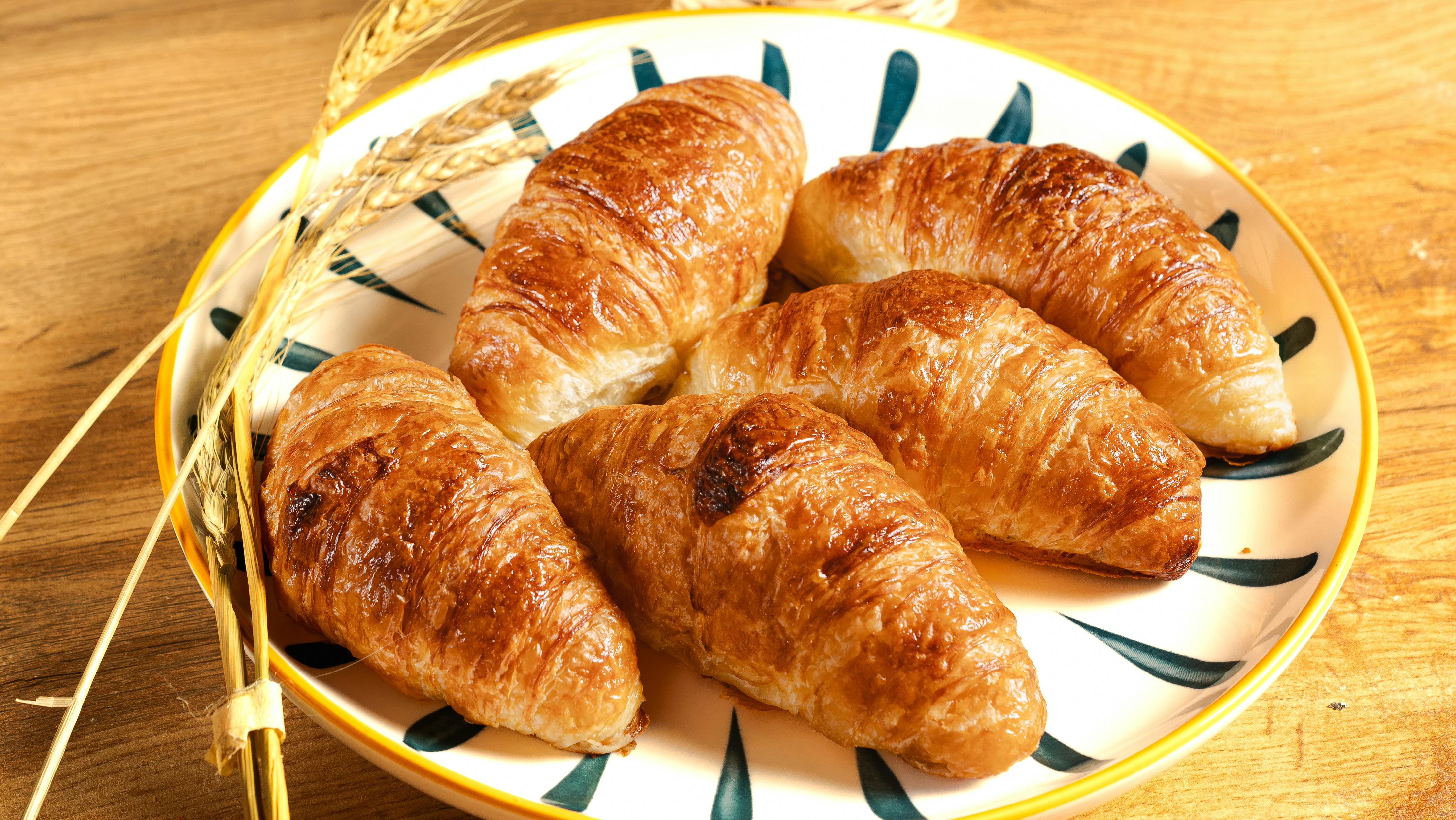 Golden Arc: Freshly Baked Croissants on a Rustic Plate