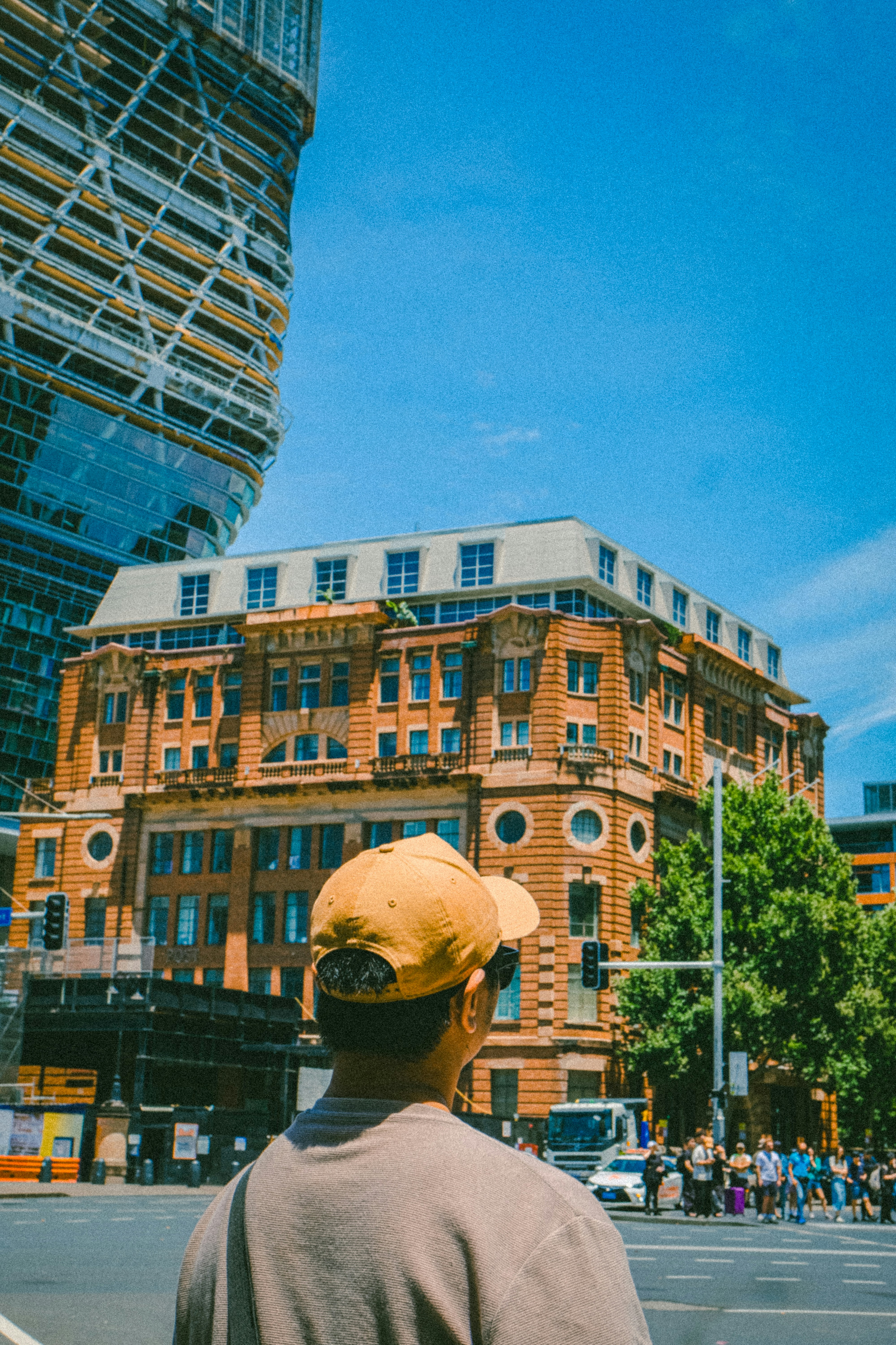 Cityscape Reverie: a traveler’s back turned toward the urban loom