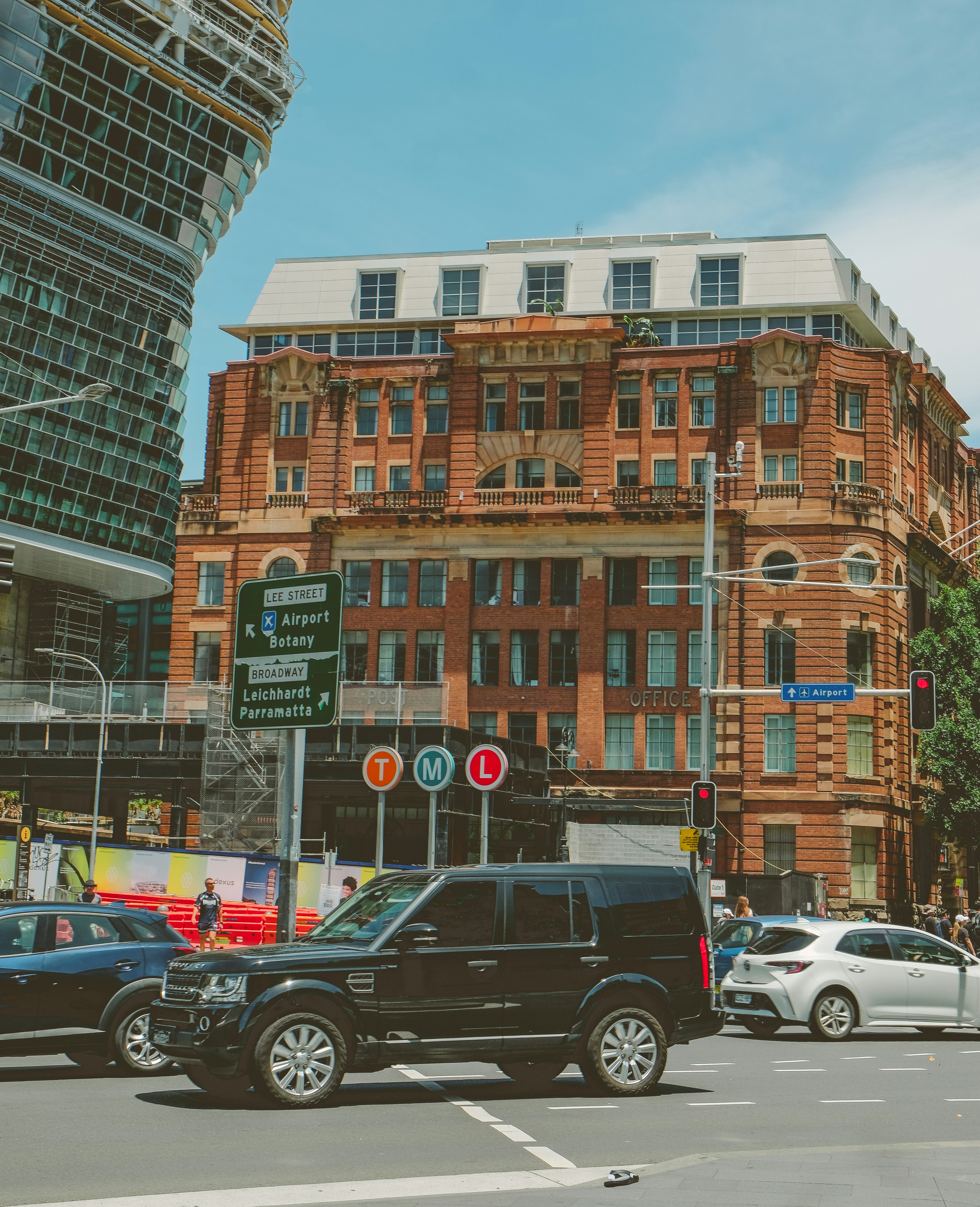 City Intersection: Red Brick Building Framed by Modern Glass Tower