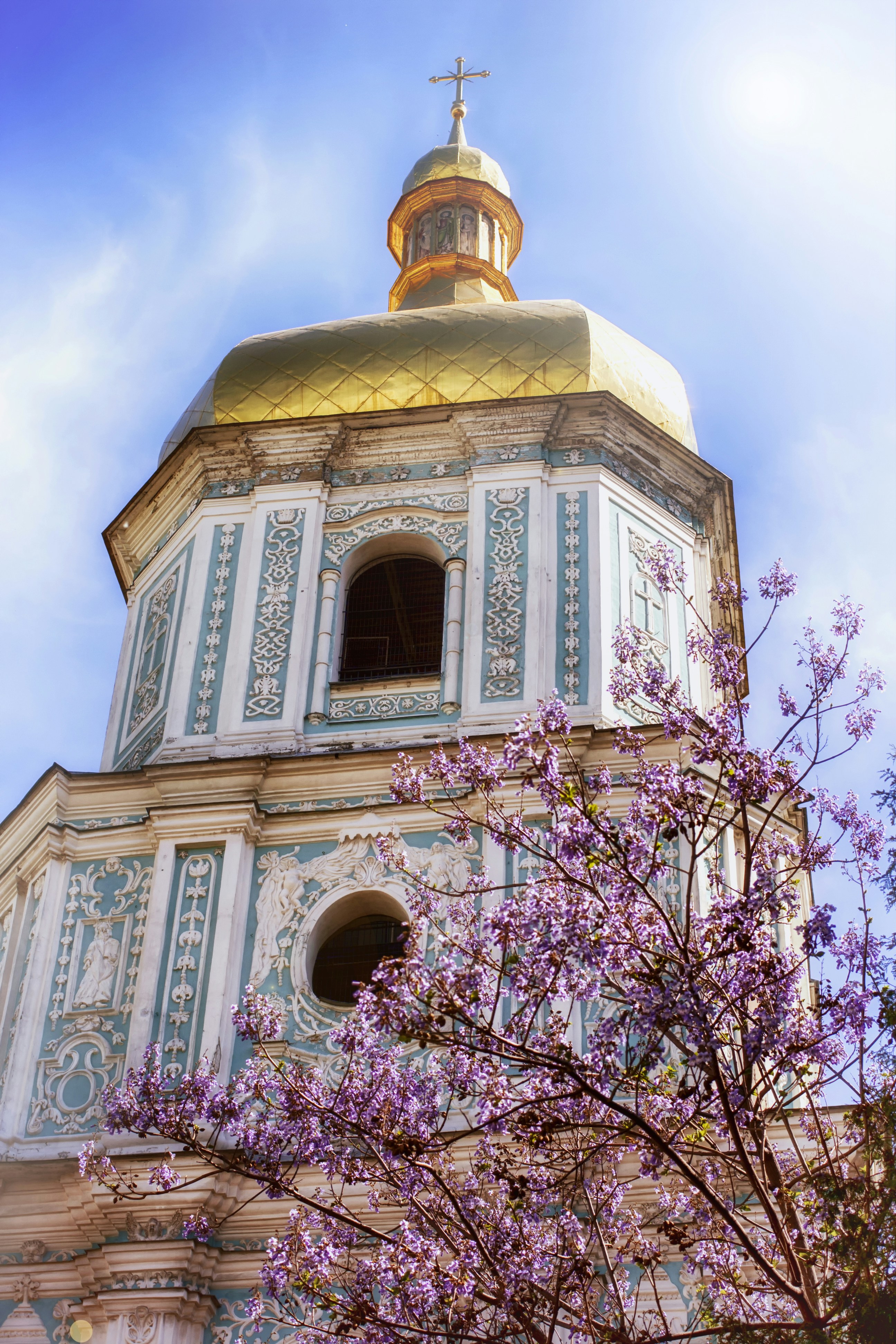 Golden Dome Rising Above LBCorn: Tulip Blossoms Frame a Ukrainian-inspired Clock Tower