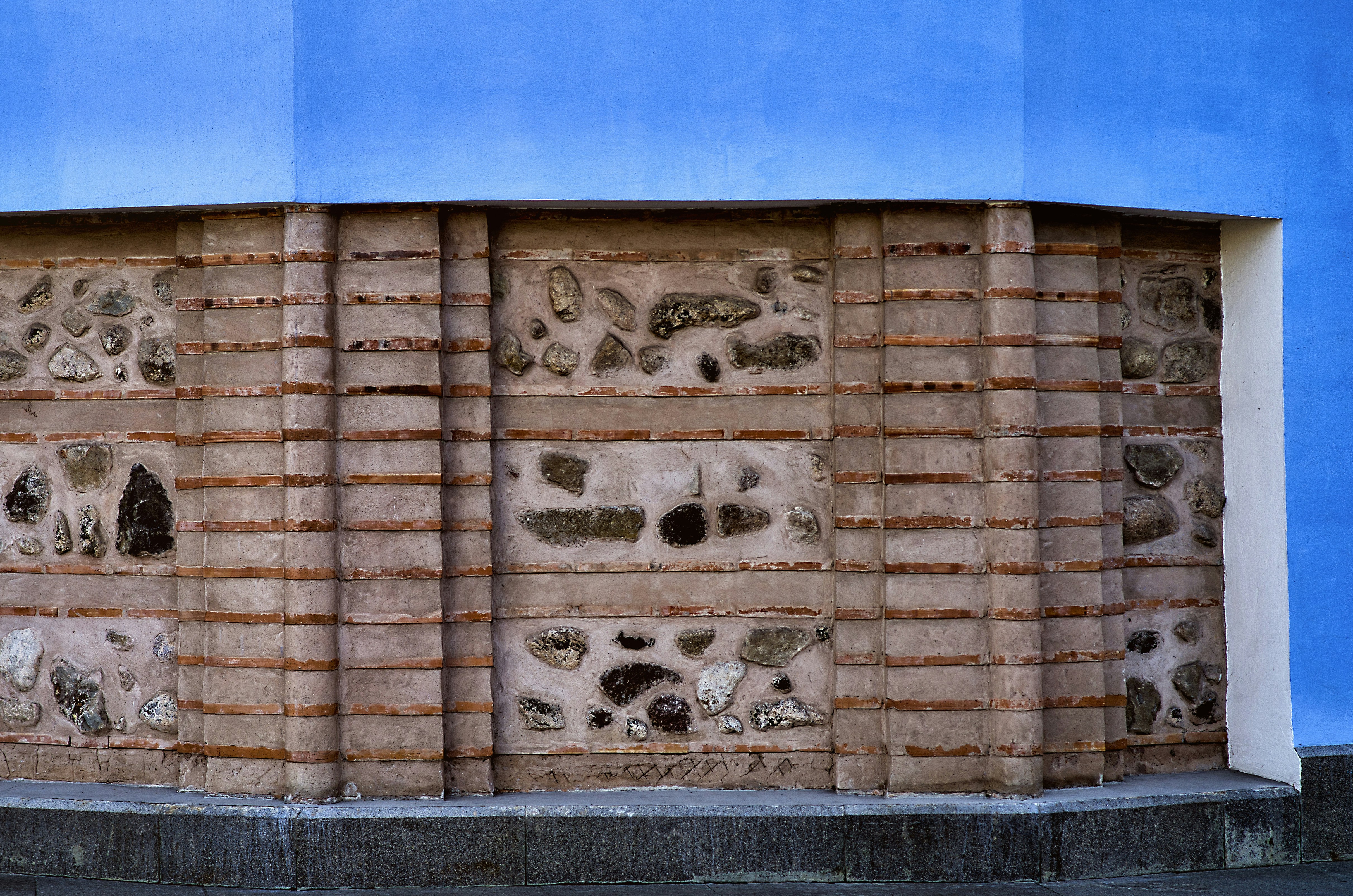 Blue Chapel Wall with Brick-and-Stone Archway